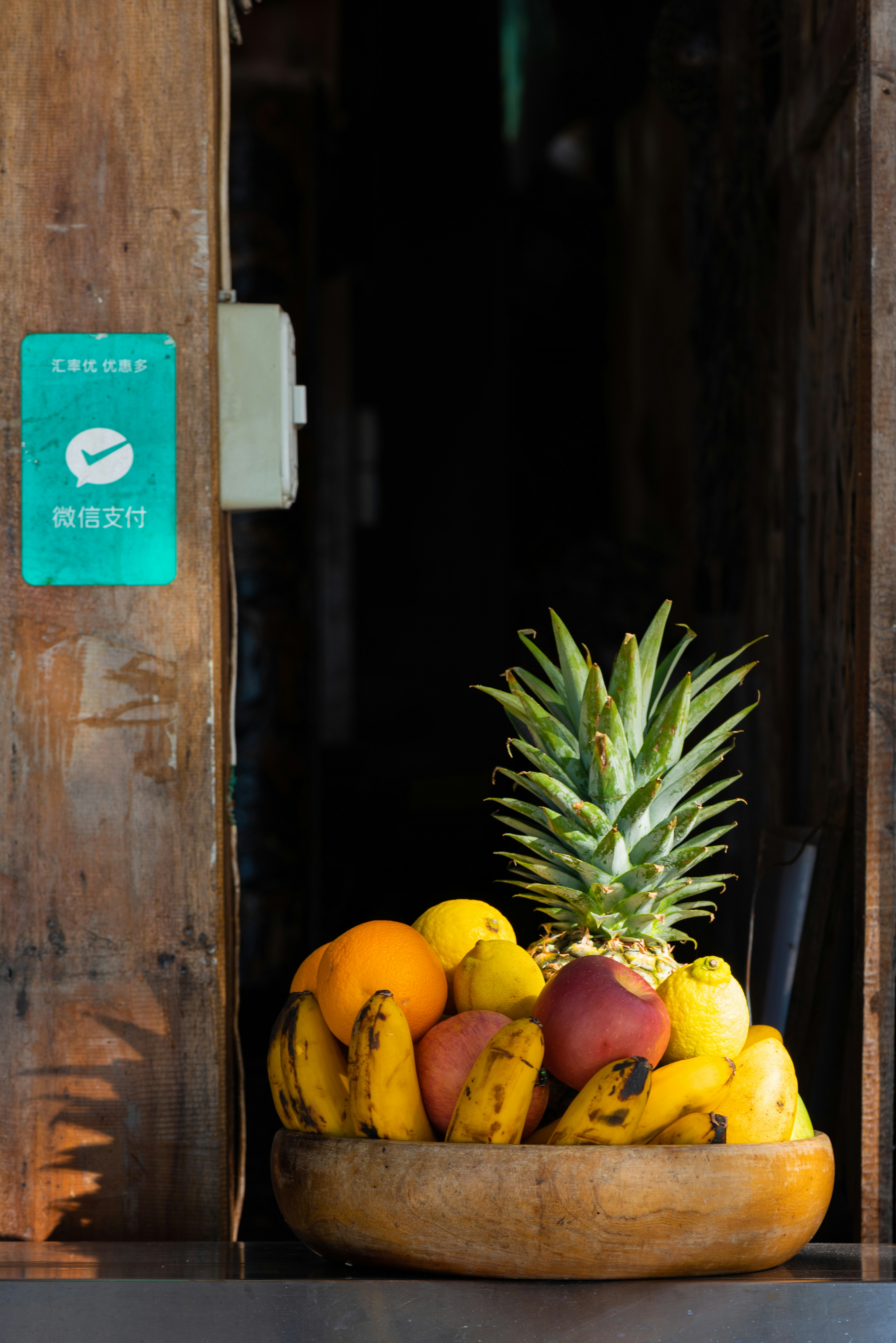 Fruit centerpiece in a rustic doorway with a pineapple crown