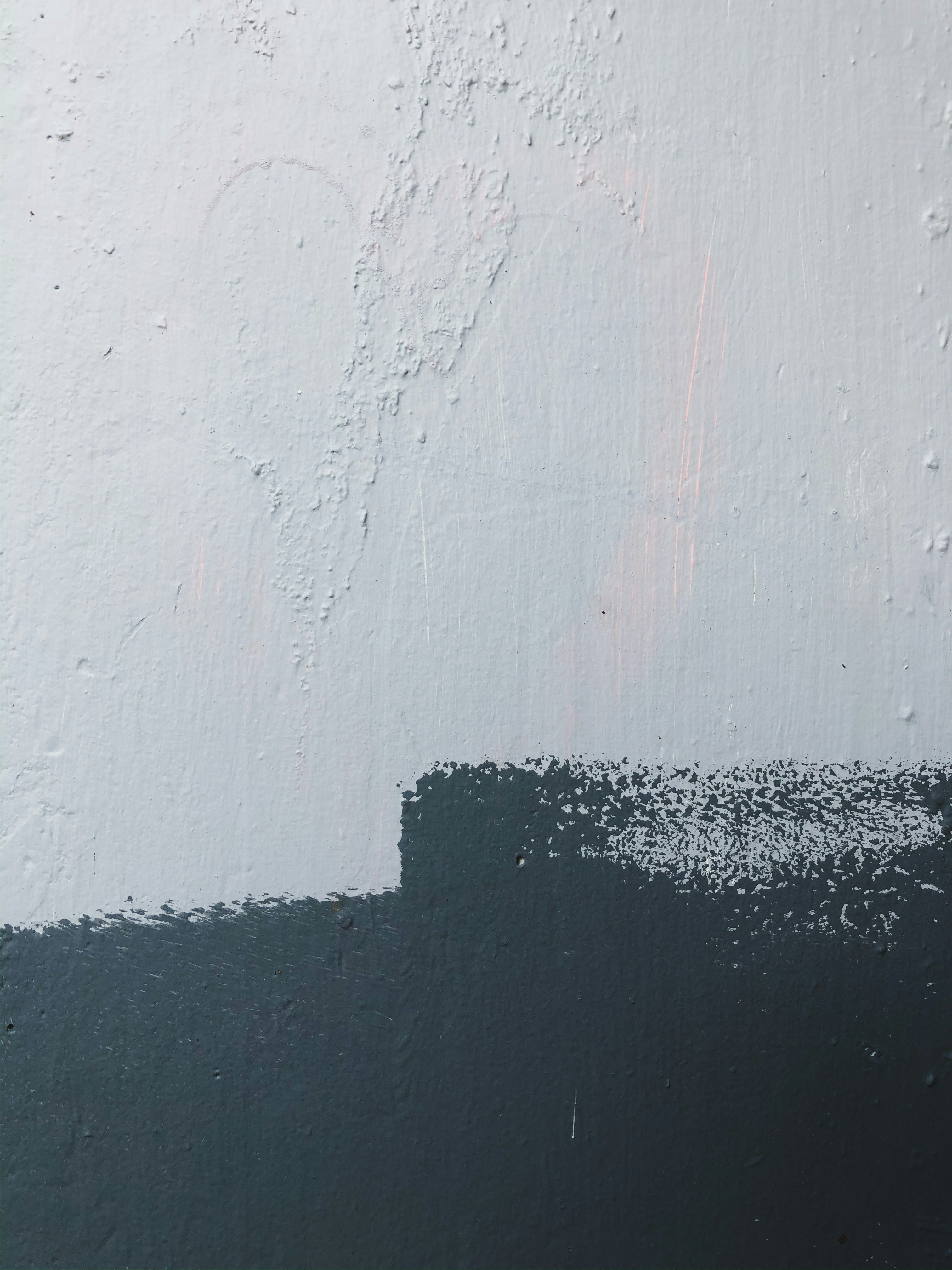 Rough white and black paint texture on a wall showcasing a stark contrast.