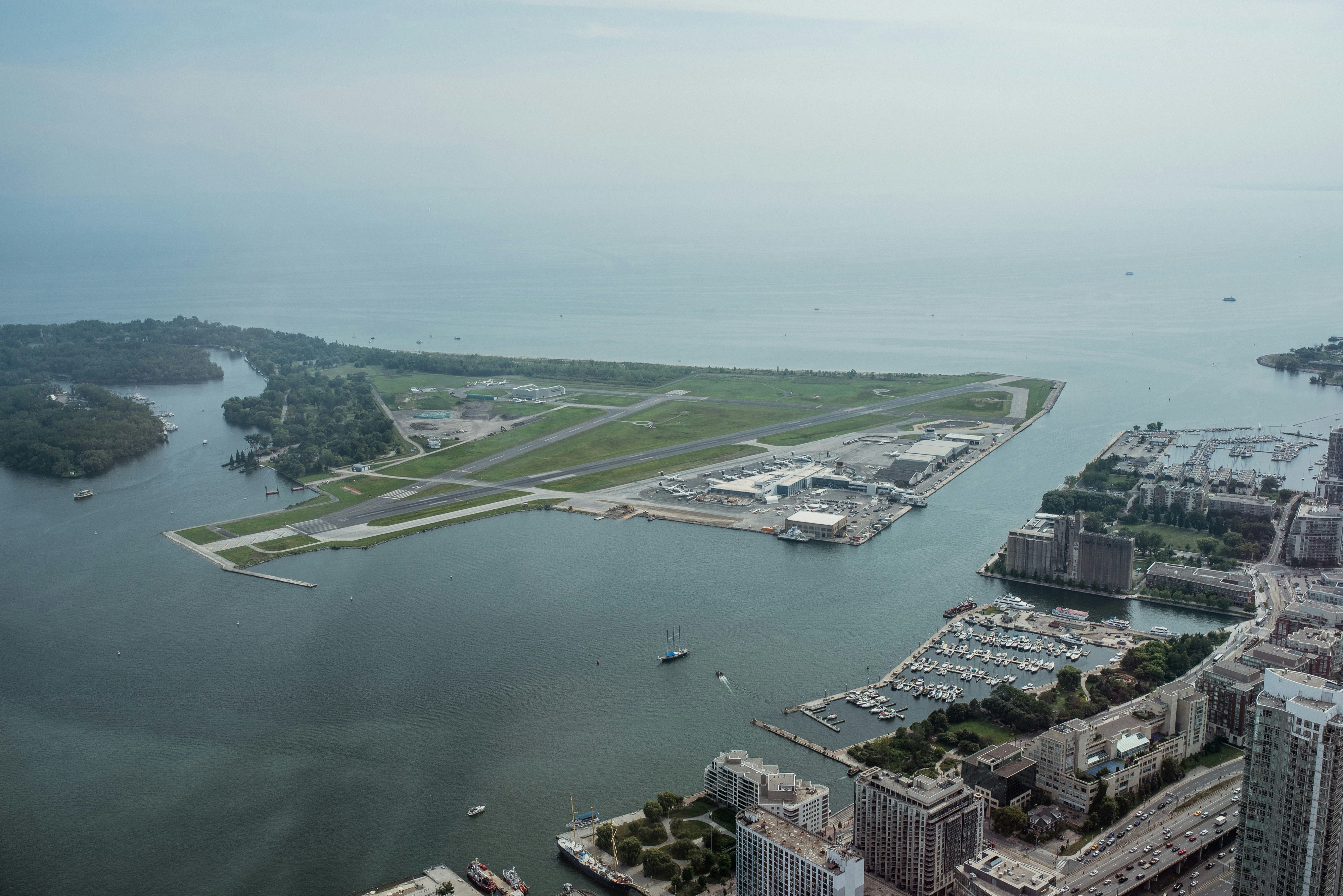 Aerial view of city buildings near body of water during daytime photo ...