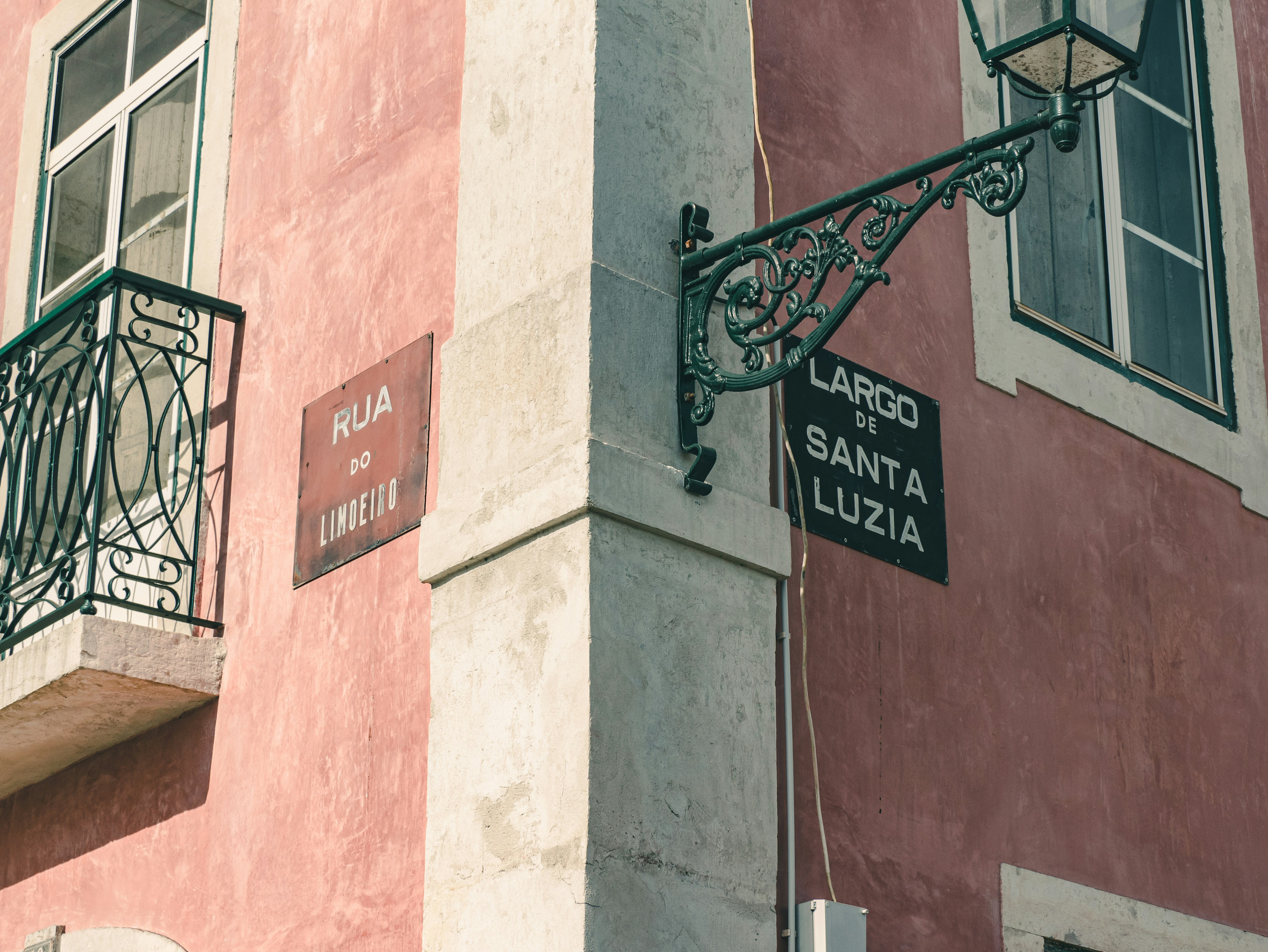 Pastel Corner: Santa Luzia Signage Framed by Wrought-Iron