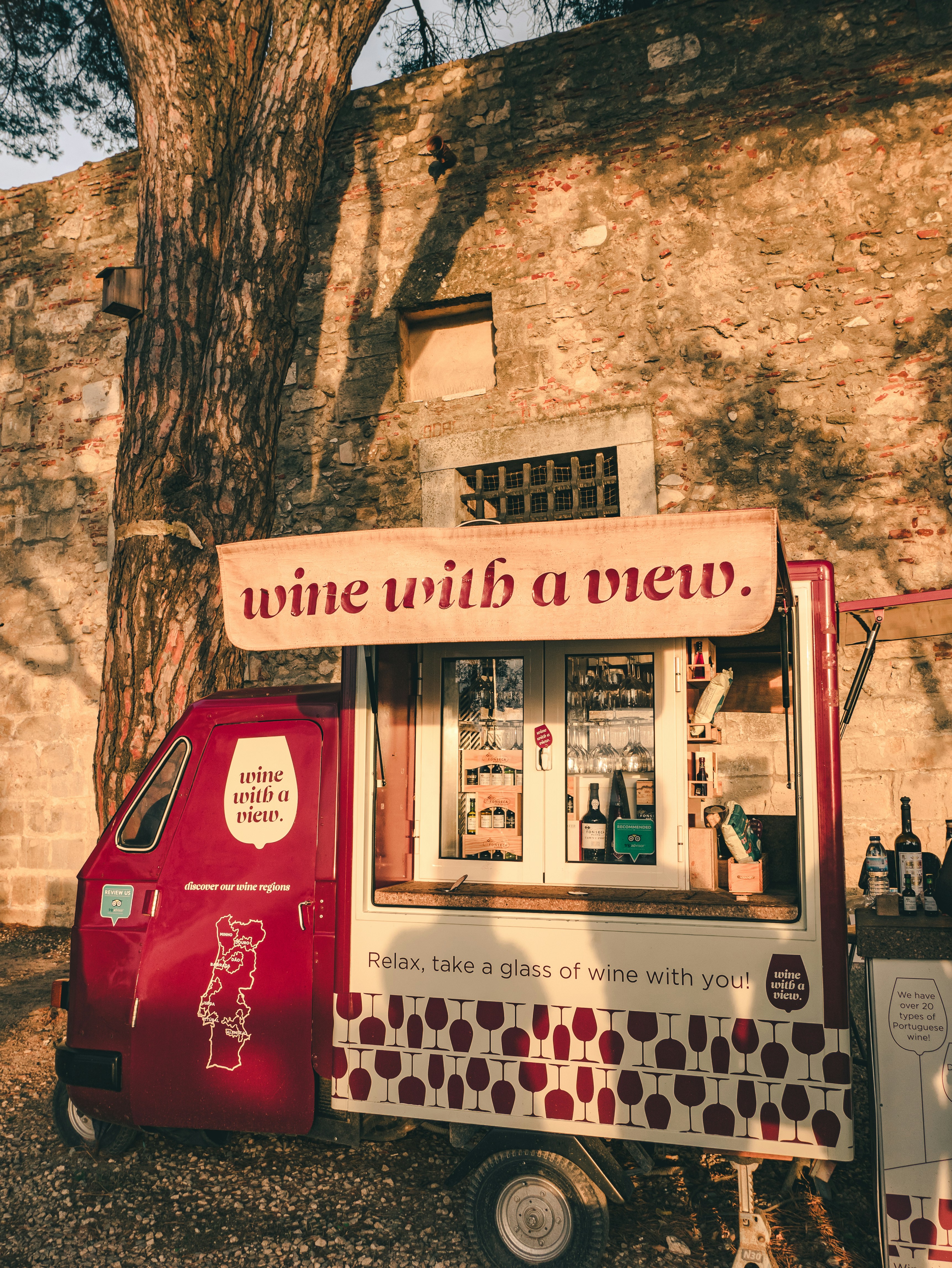 Wine Truck by the Stone Wall: A Sunlit Stopover
