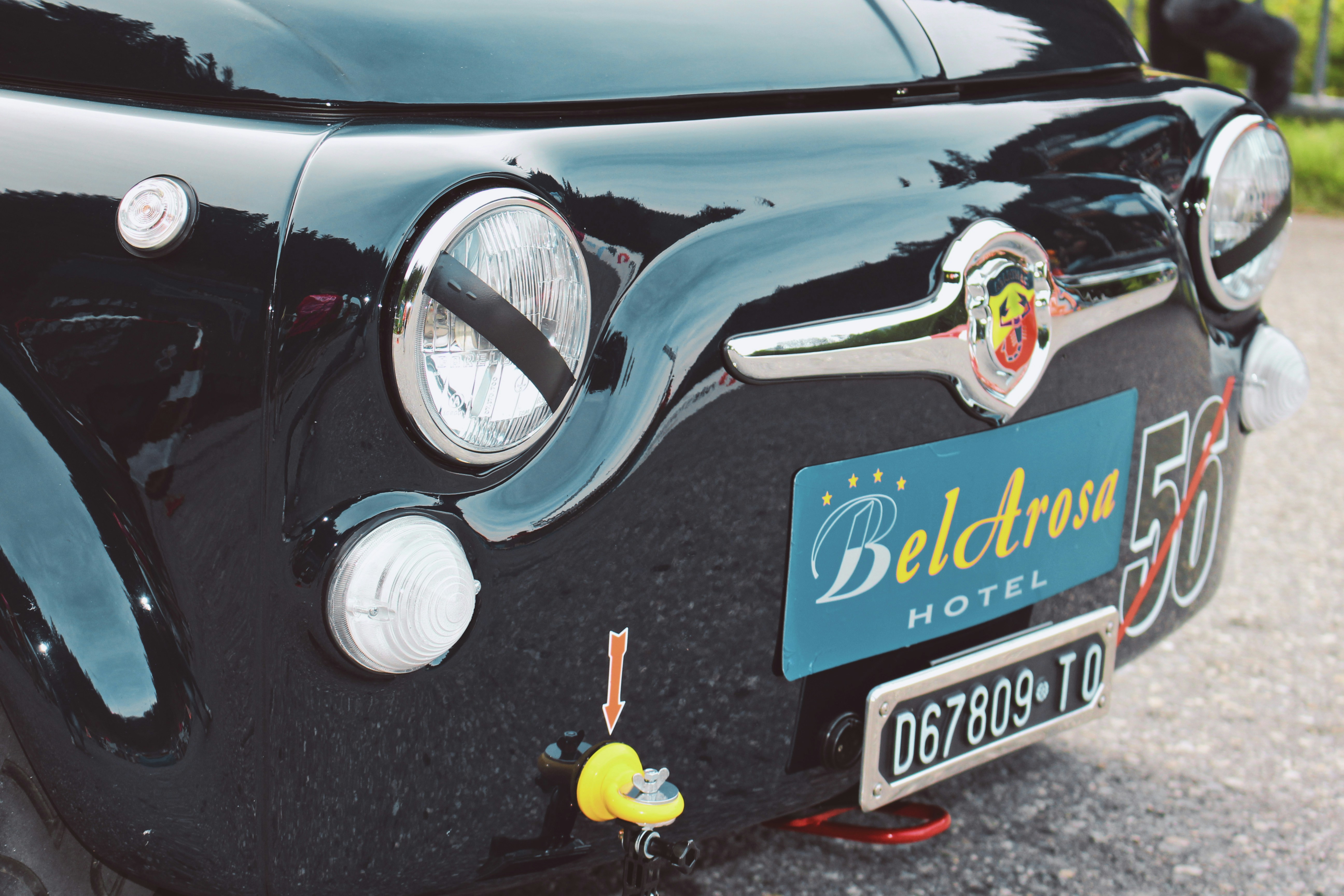 Chrome Grin and the Yellow Hook: A Vintage Car's Front Portrait