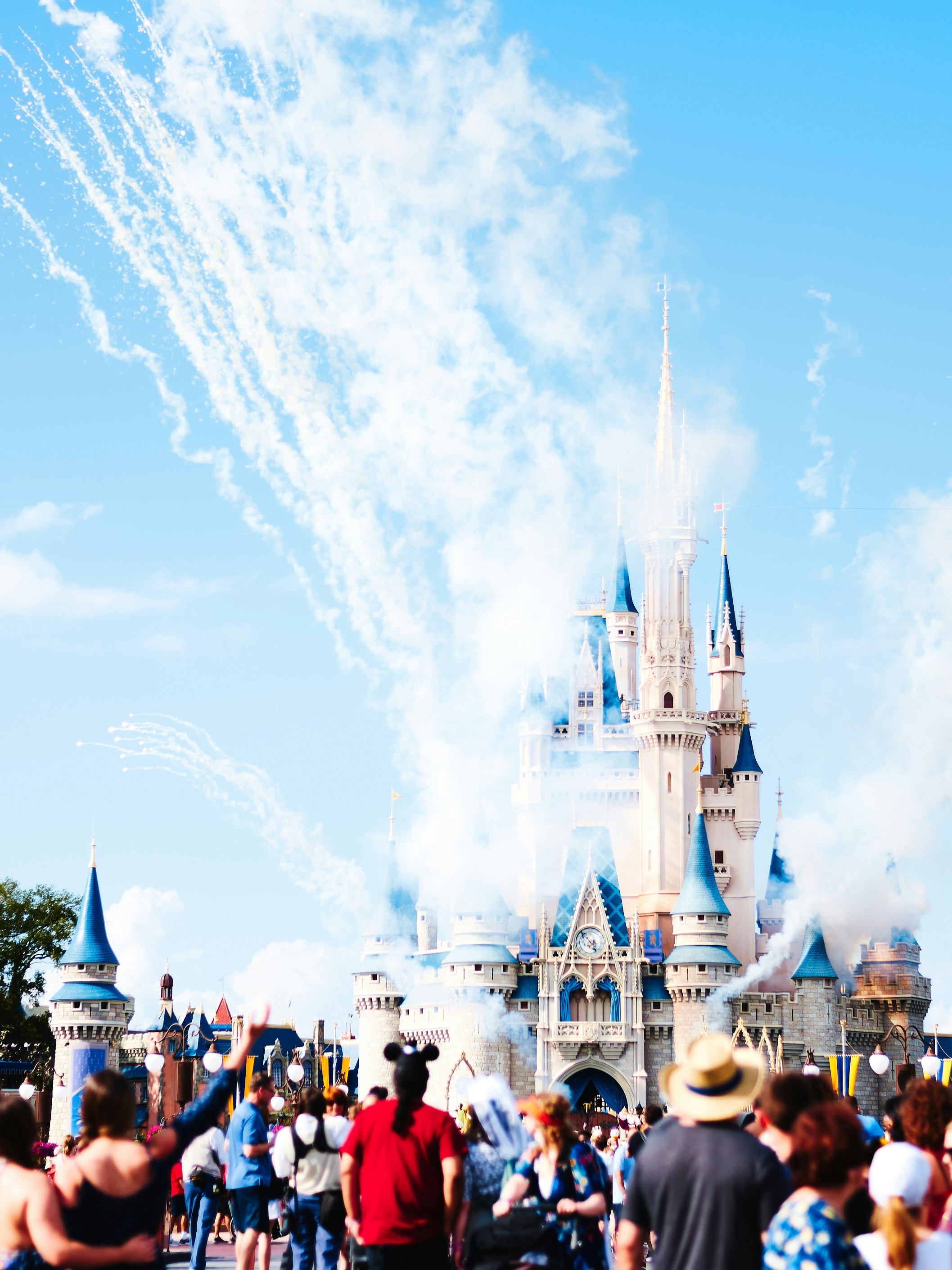 Magic + Chaos | people walking on white concrete building under blue sky during daytime