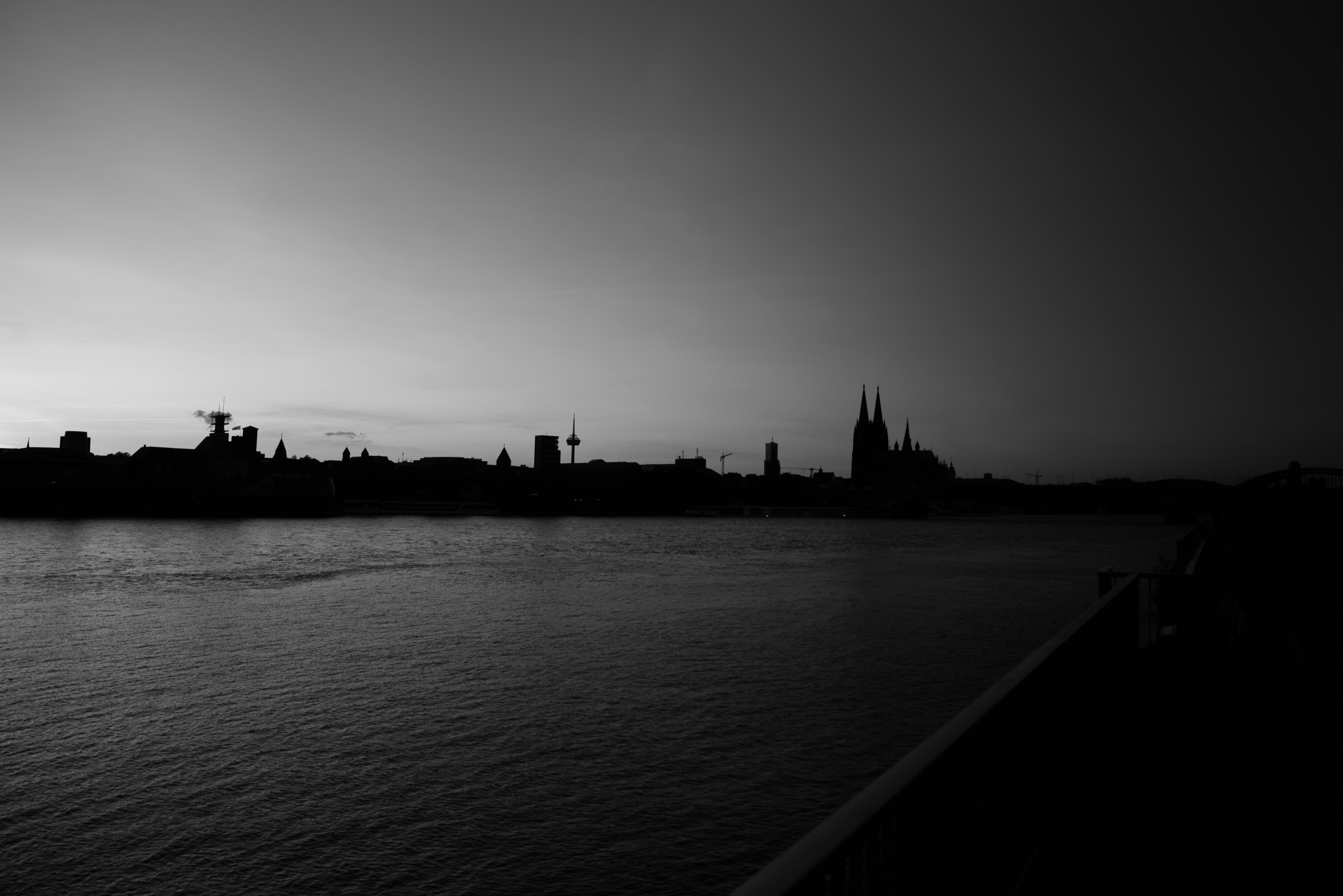 Dusk Silhouette Over the River: Twin Spires Crown the City Horizon