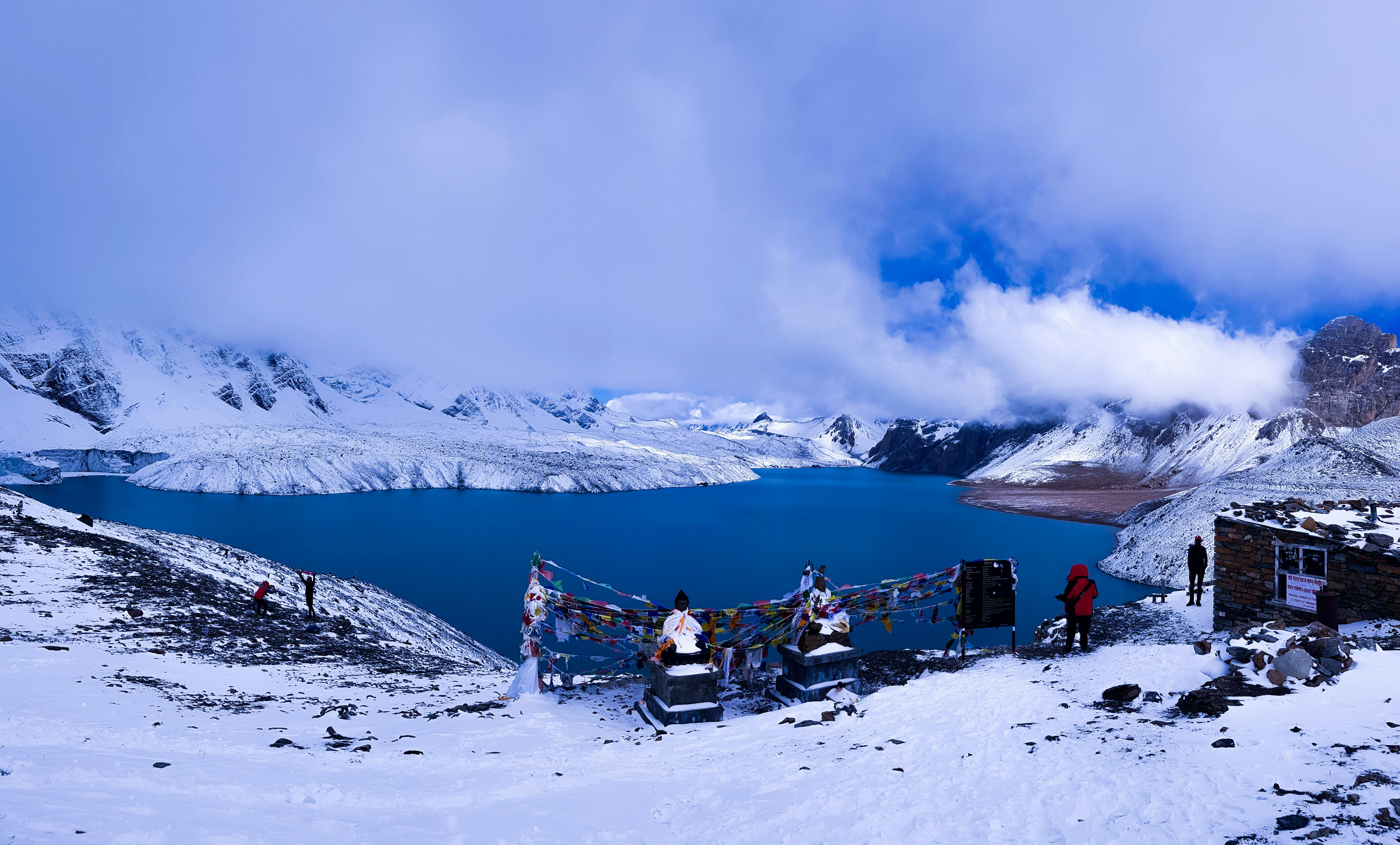 People riding on sled on snow covered ground during daytime photo ...