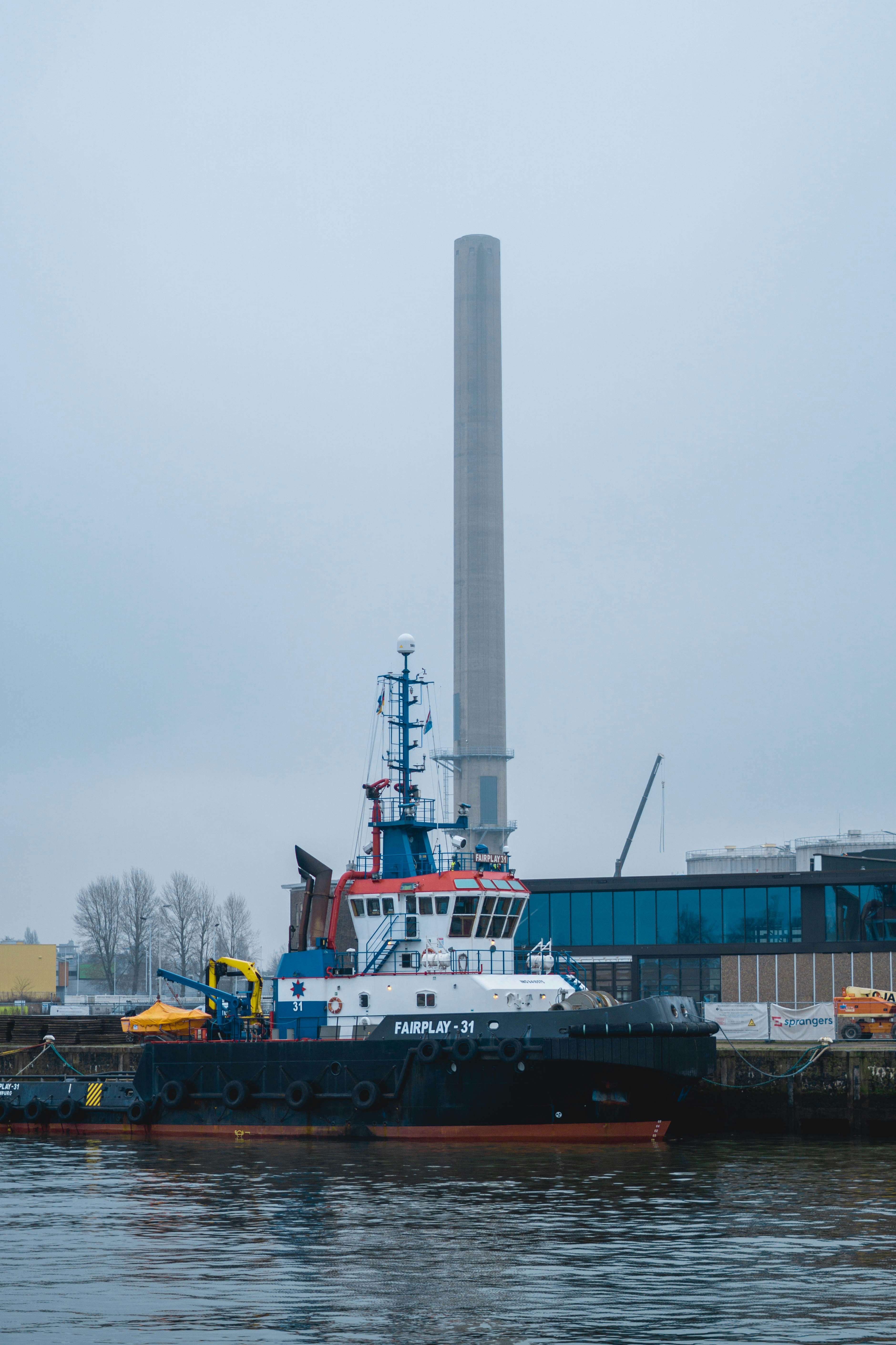 Tugboat at the Edge of Industry by a Quiet Wharf