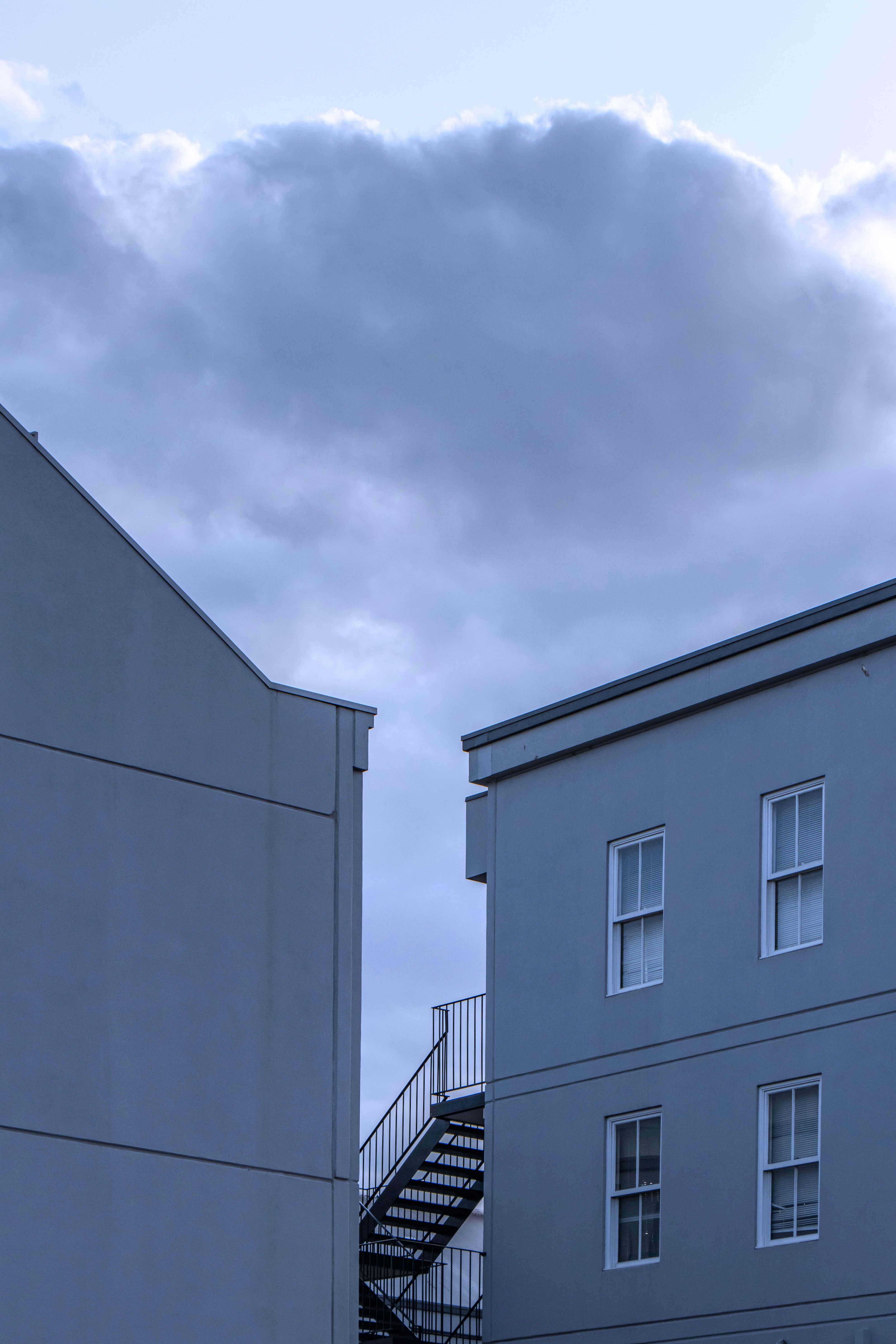 gray concrete building under white clouds during daytime