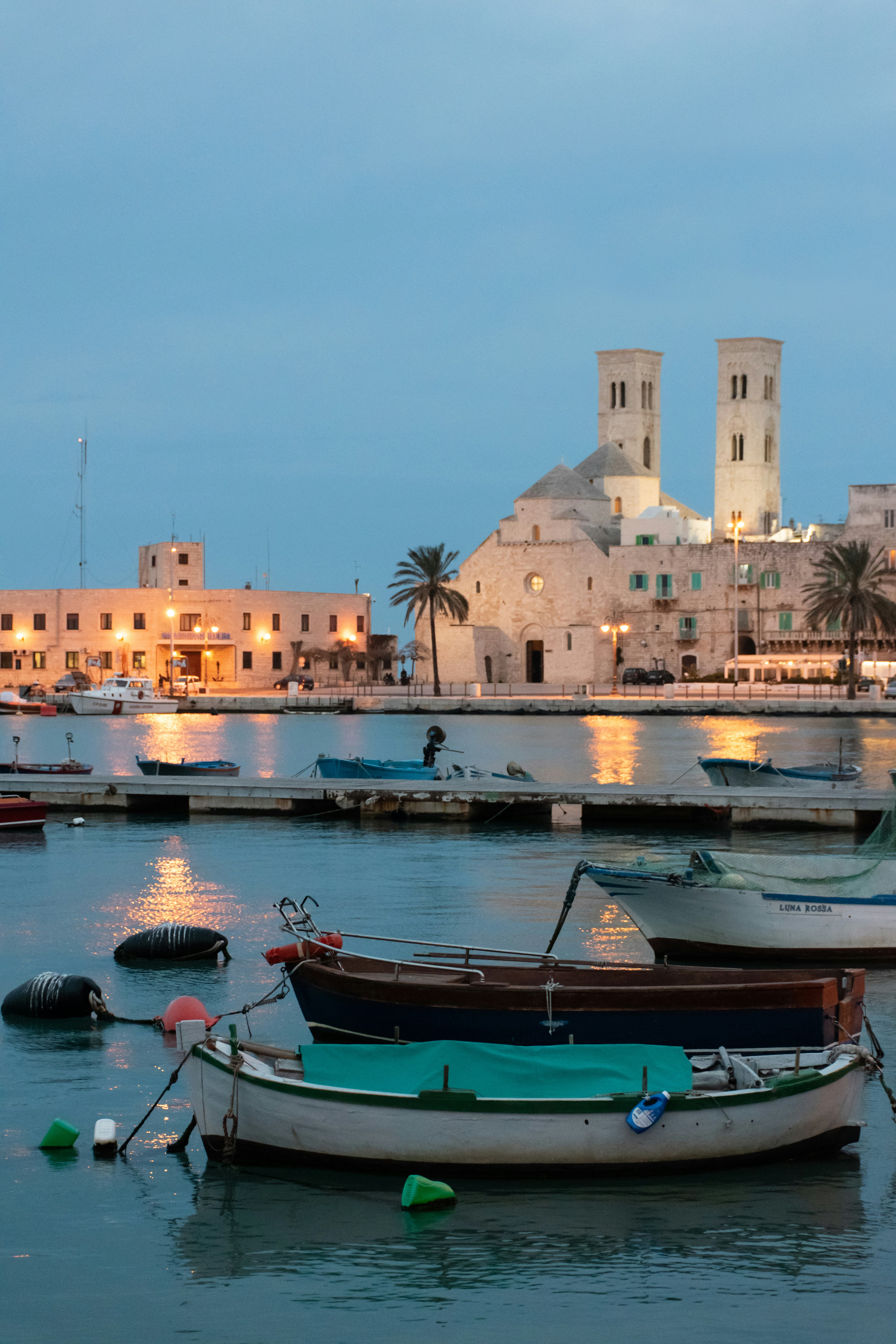 Duomo "San Corrado" in Molfetta, Bari | blue and red boat on dock during daytime