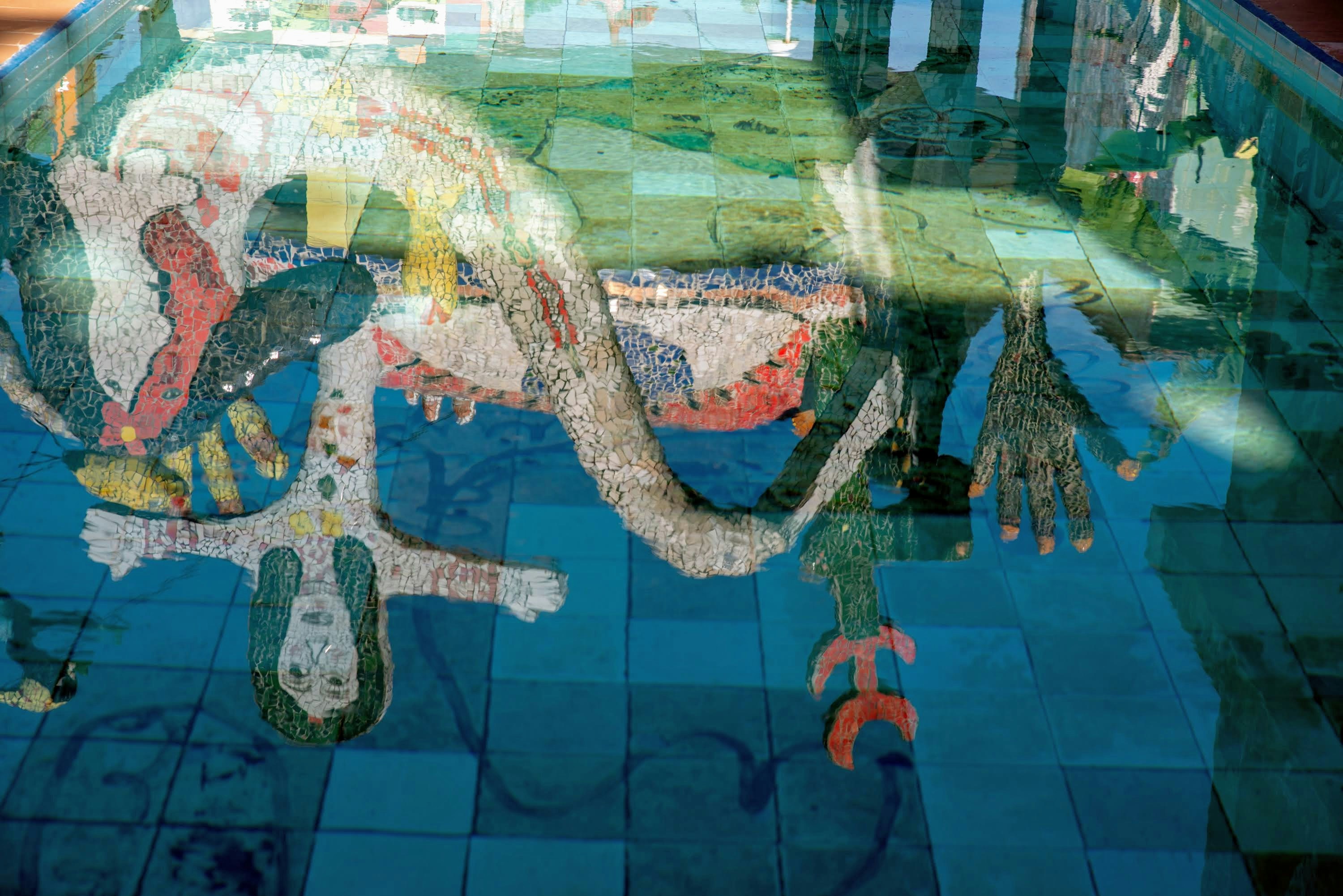 Underwater Mosaic Portrait: A Whimsical Cartoon Scene Painted on Pool Tiles