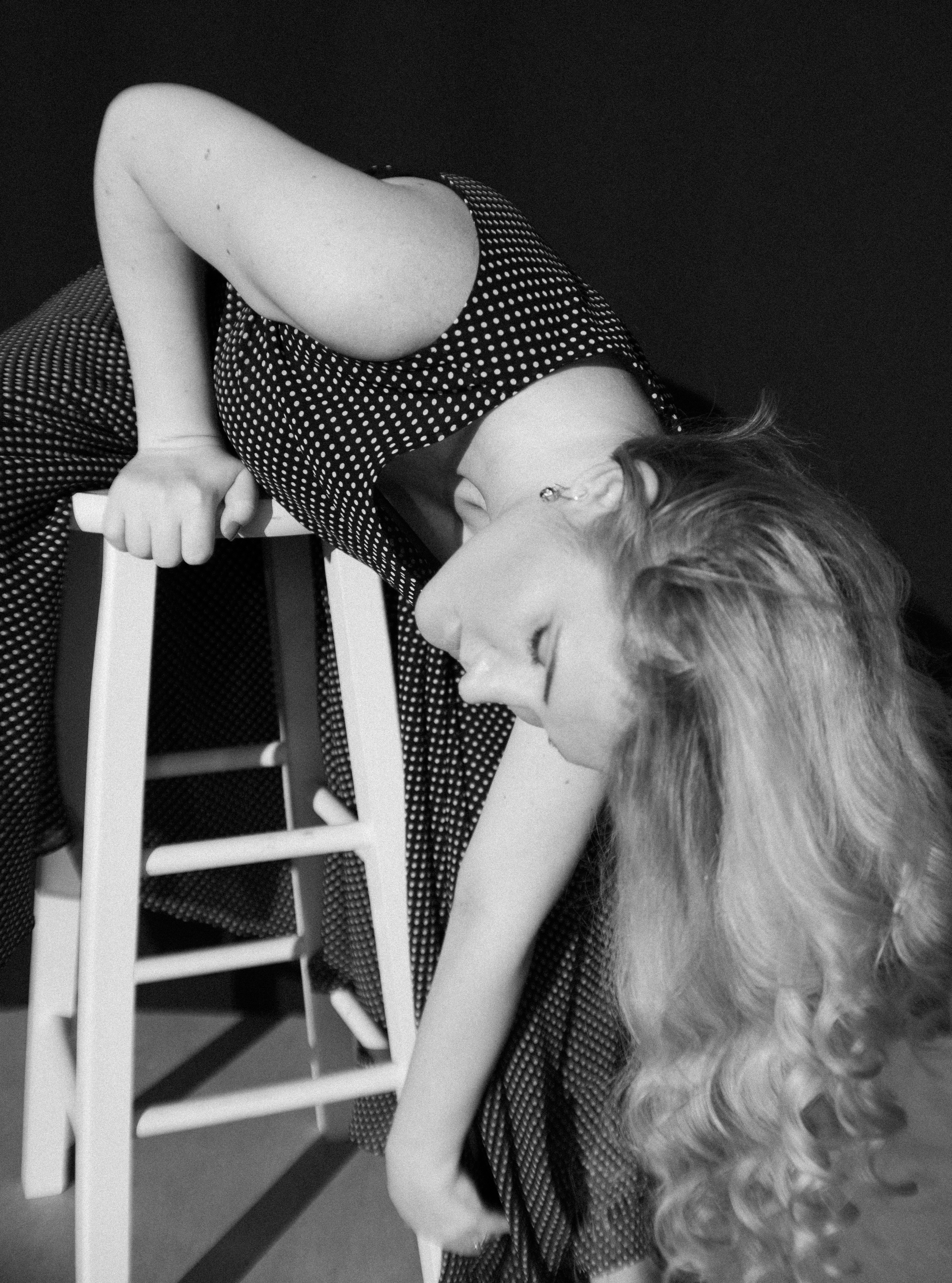 Noir in Dots: A Backbend Portrait on a White Stool