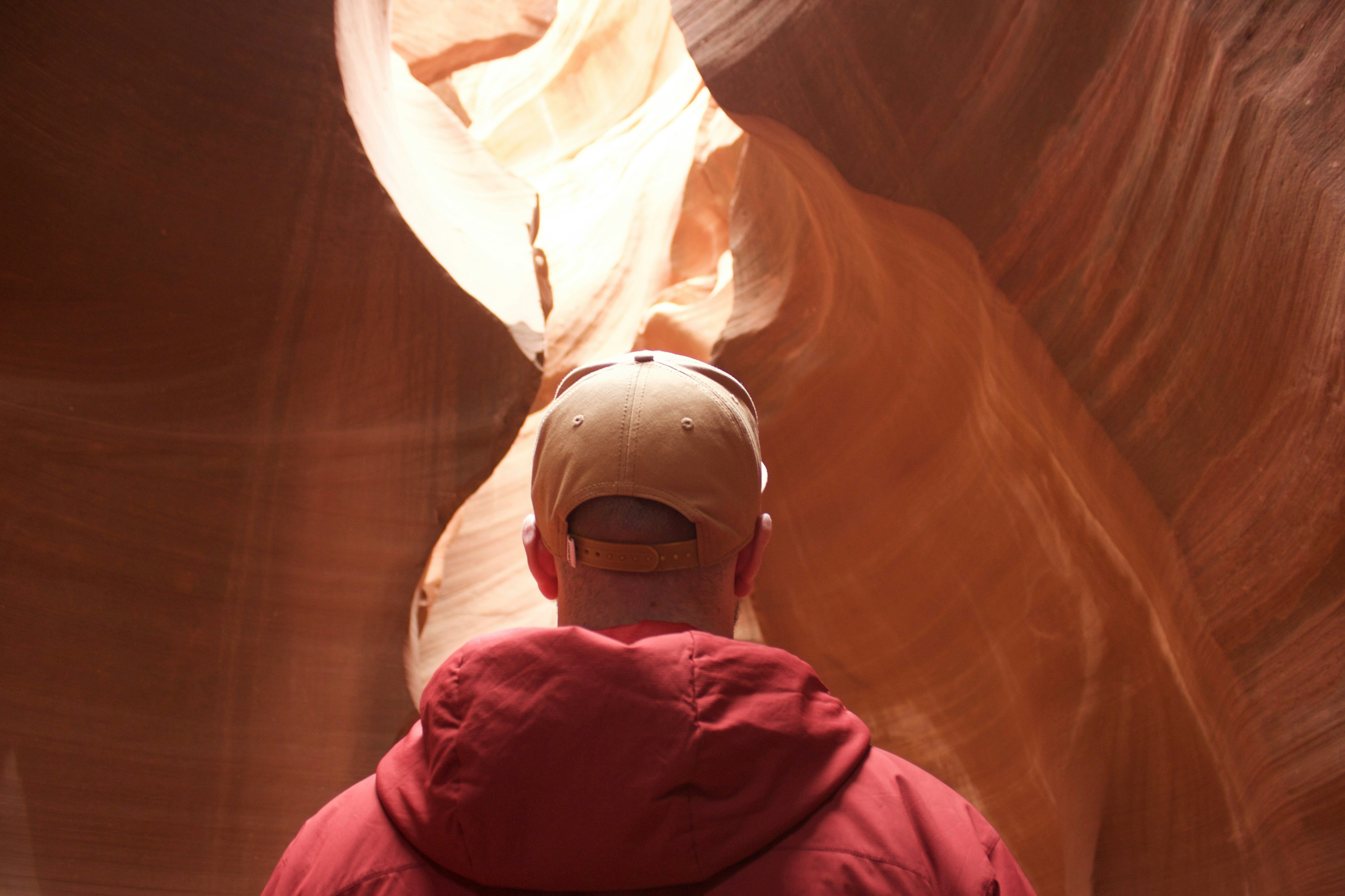 Red-Clad Wanderer in a Sunlit Slot Canyon