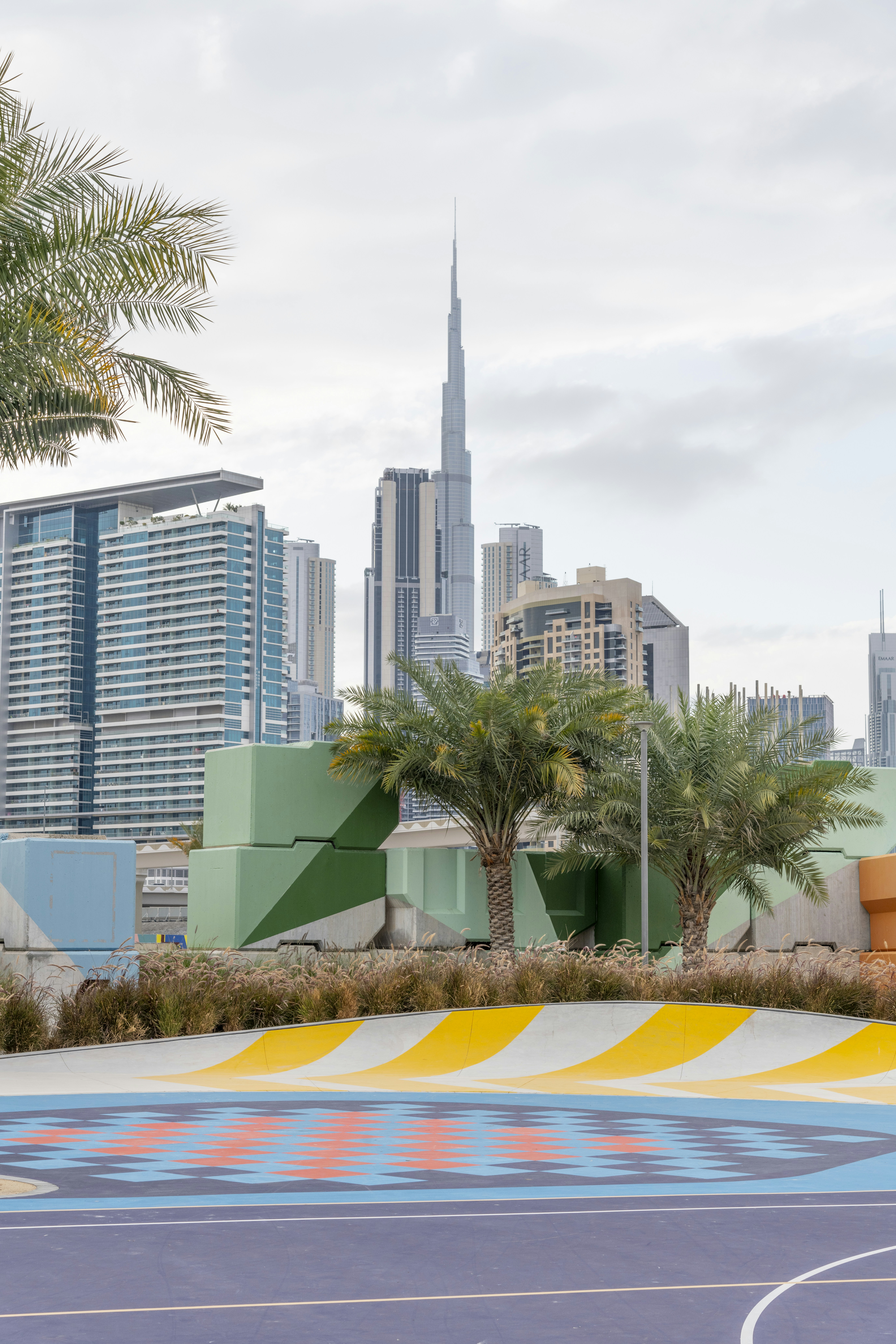 Cityscape Foundry: Palm Trees and Bursting Geometry Against the Skyline