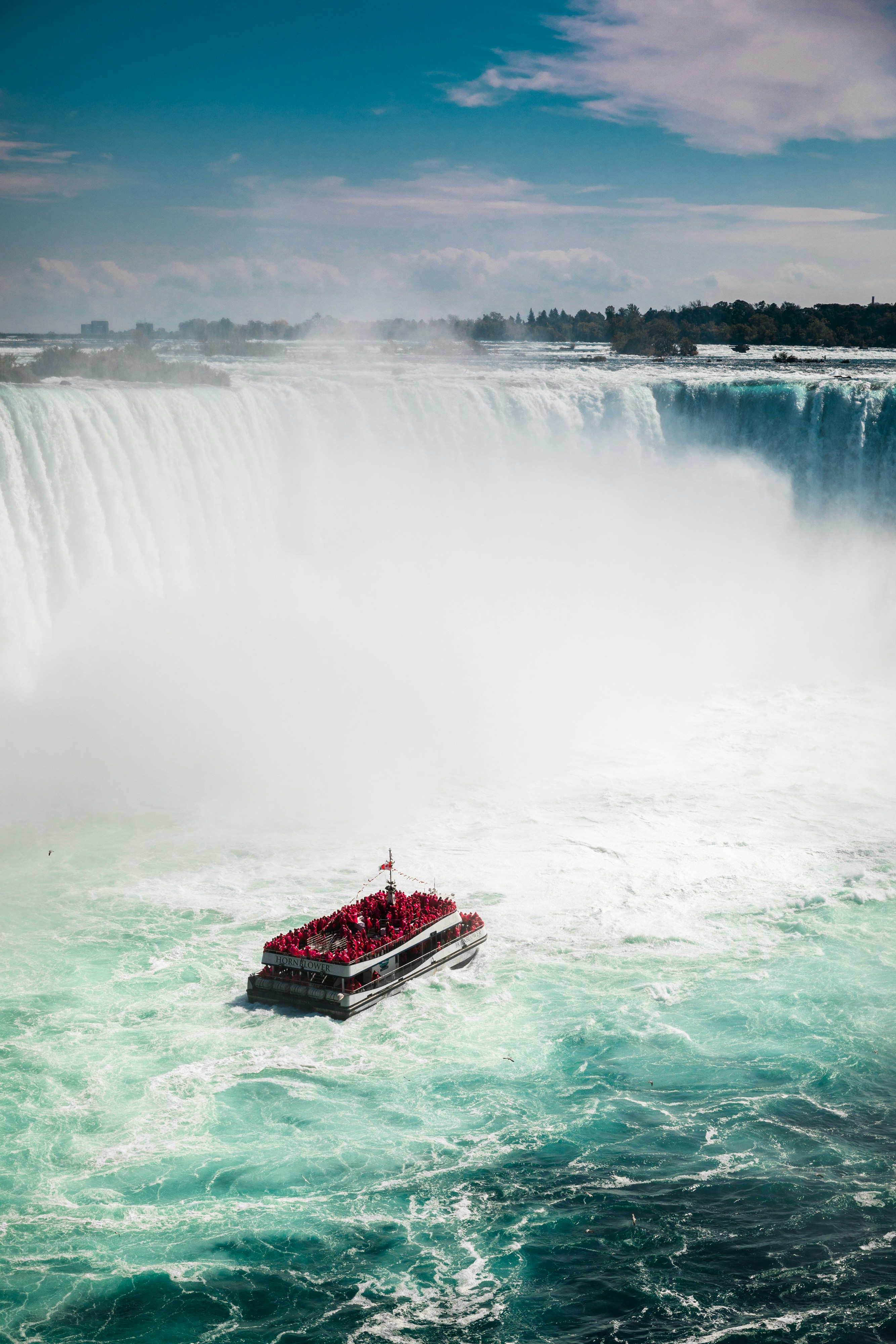 red boat on water falls during daytime