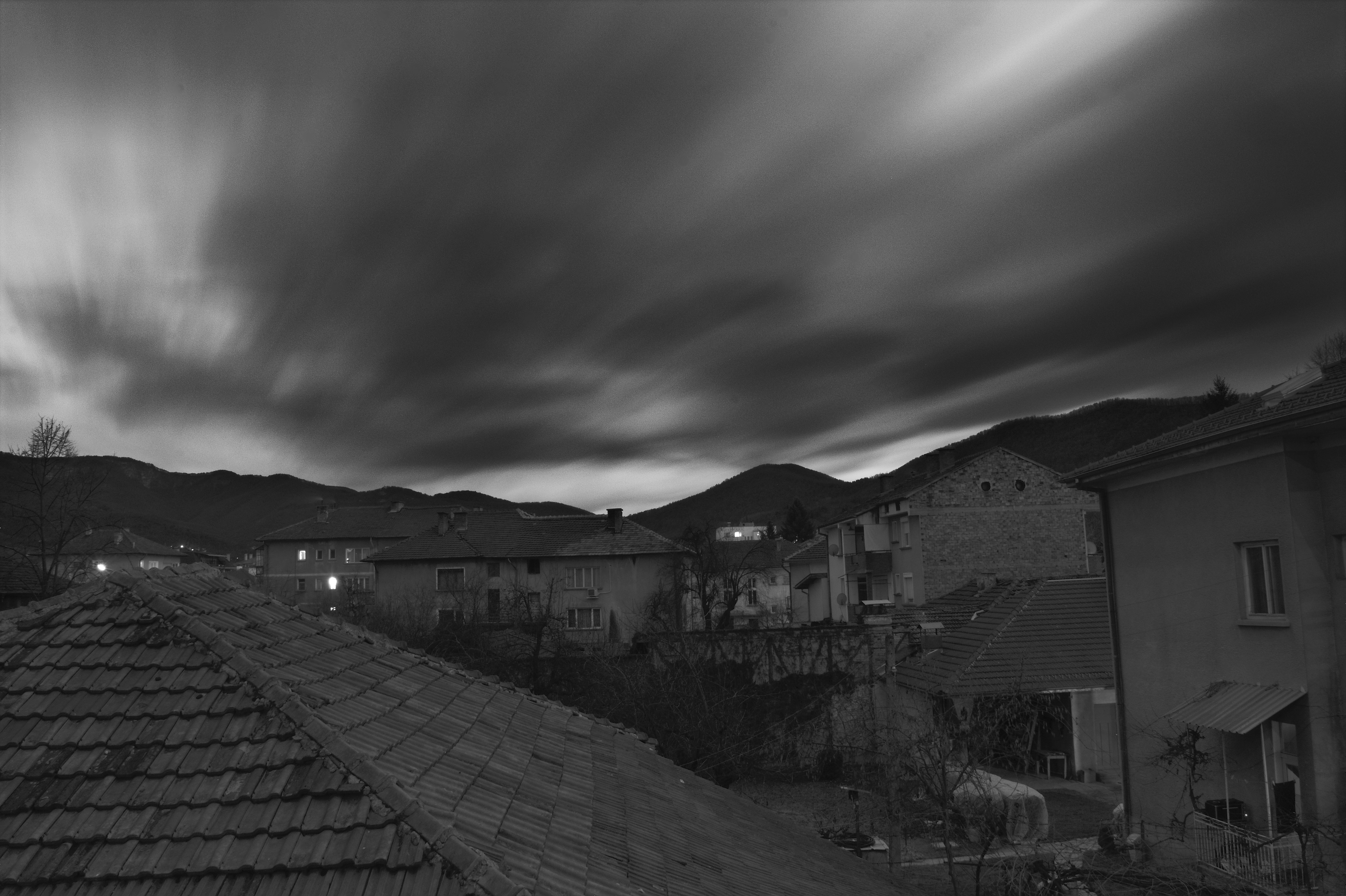Storm-Swept Rooftops Beneath Looming Clouds