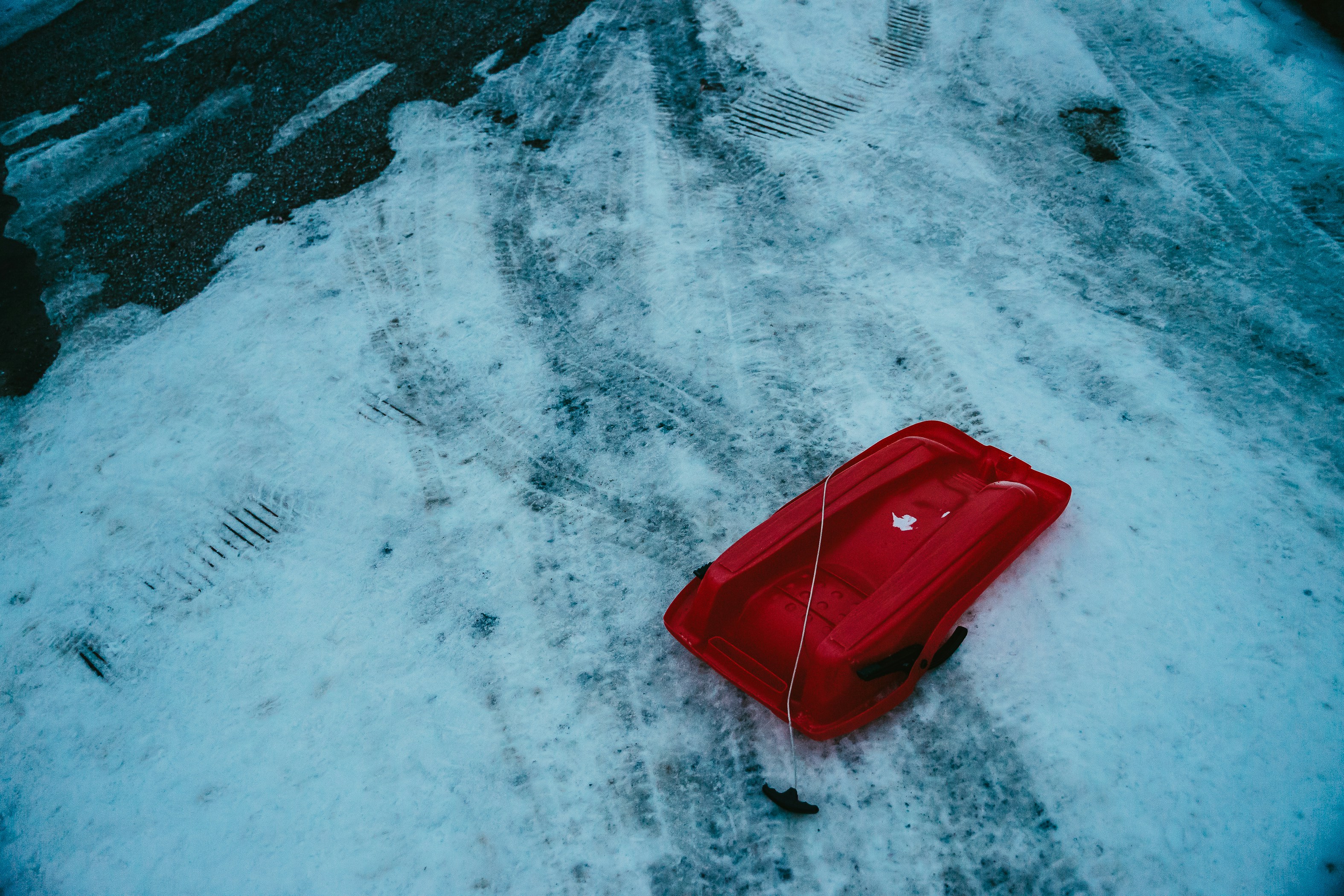 red car on snow covered road