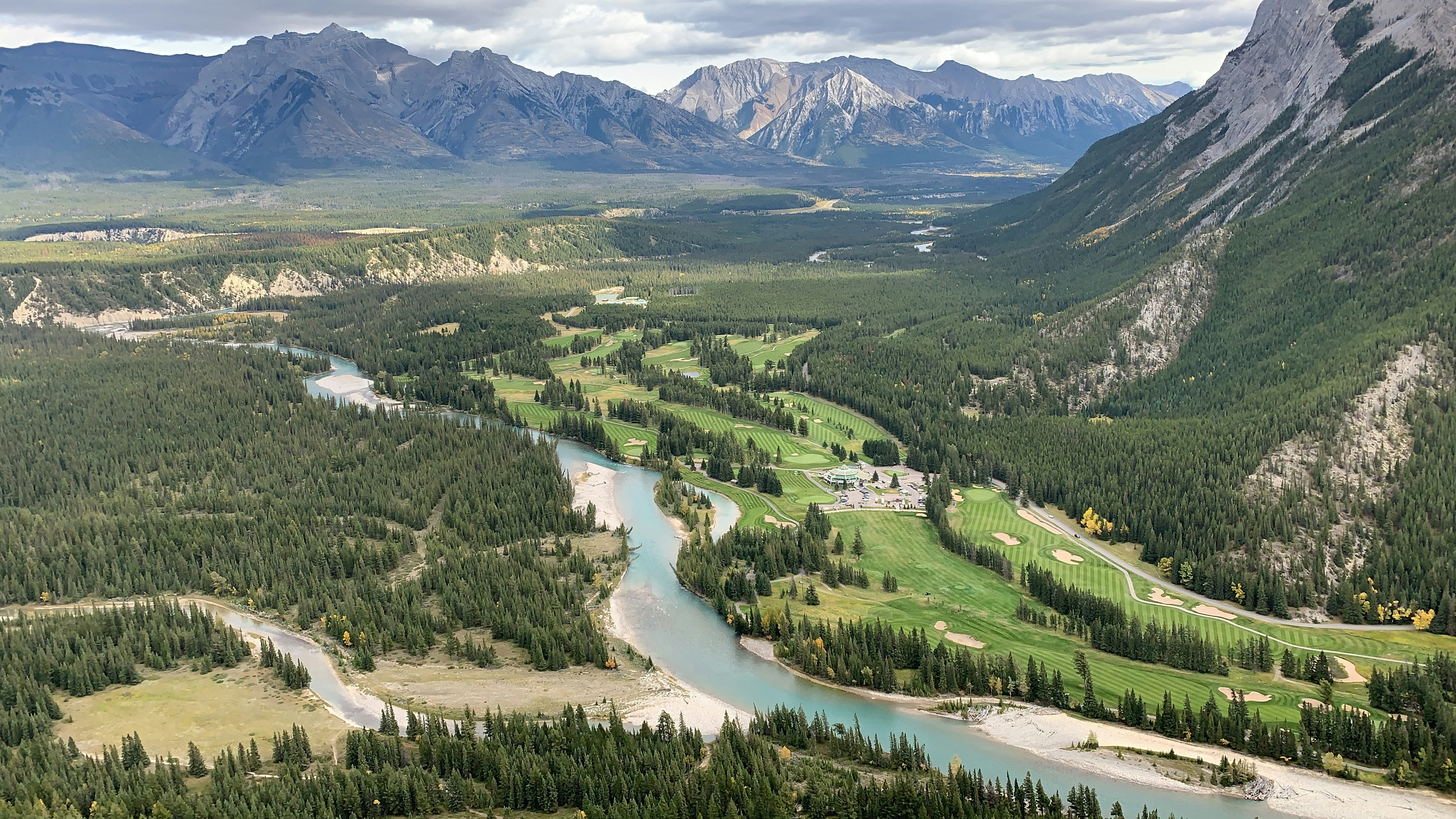 Verdant River Meanders Through Alpine Valley