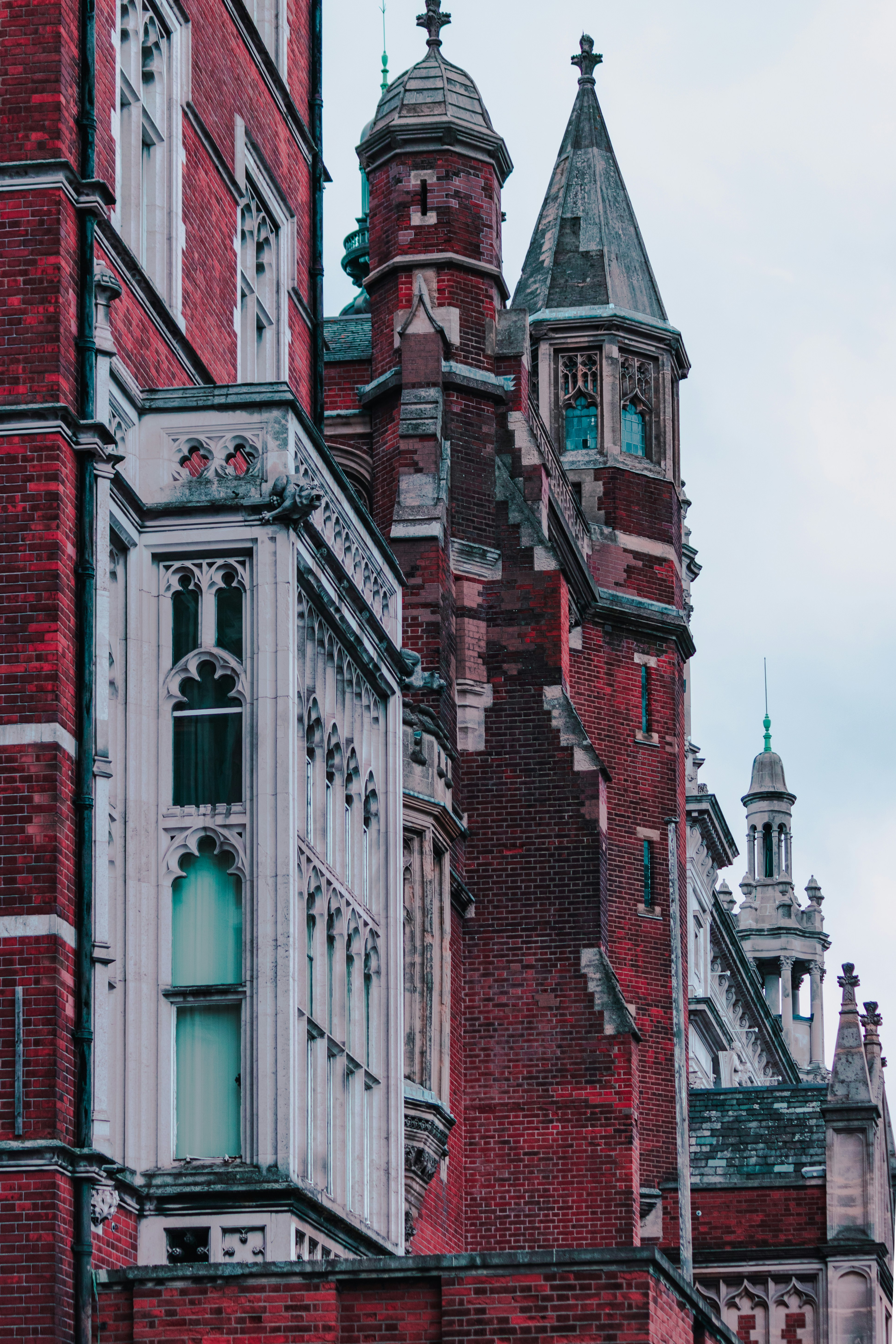 Red Brick Turrets Ascend Between White Arches