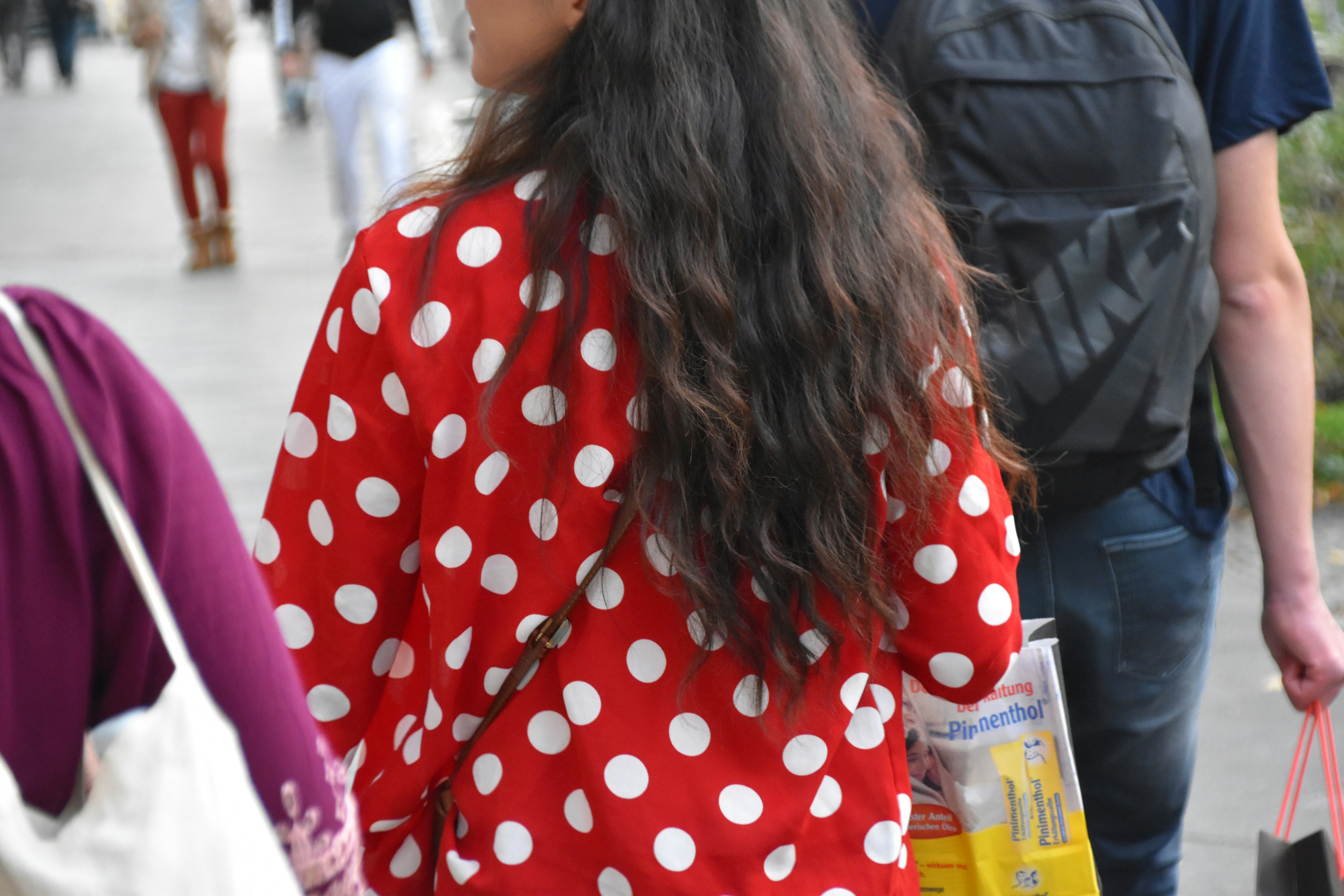 Red Polka Dot Emissary on a Busy Street