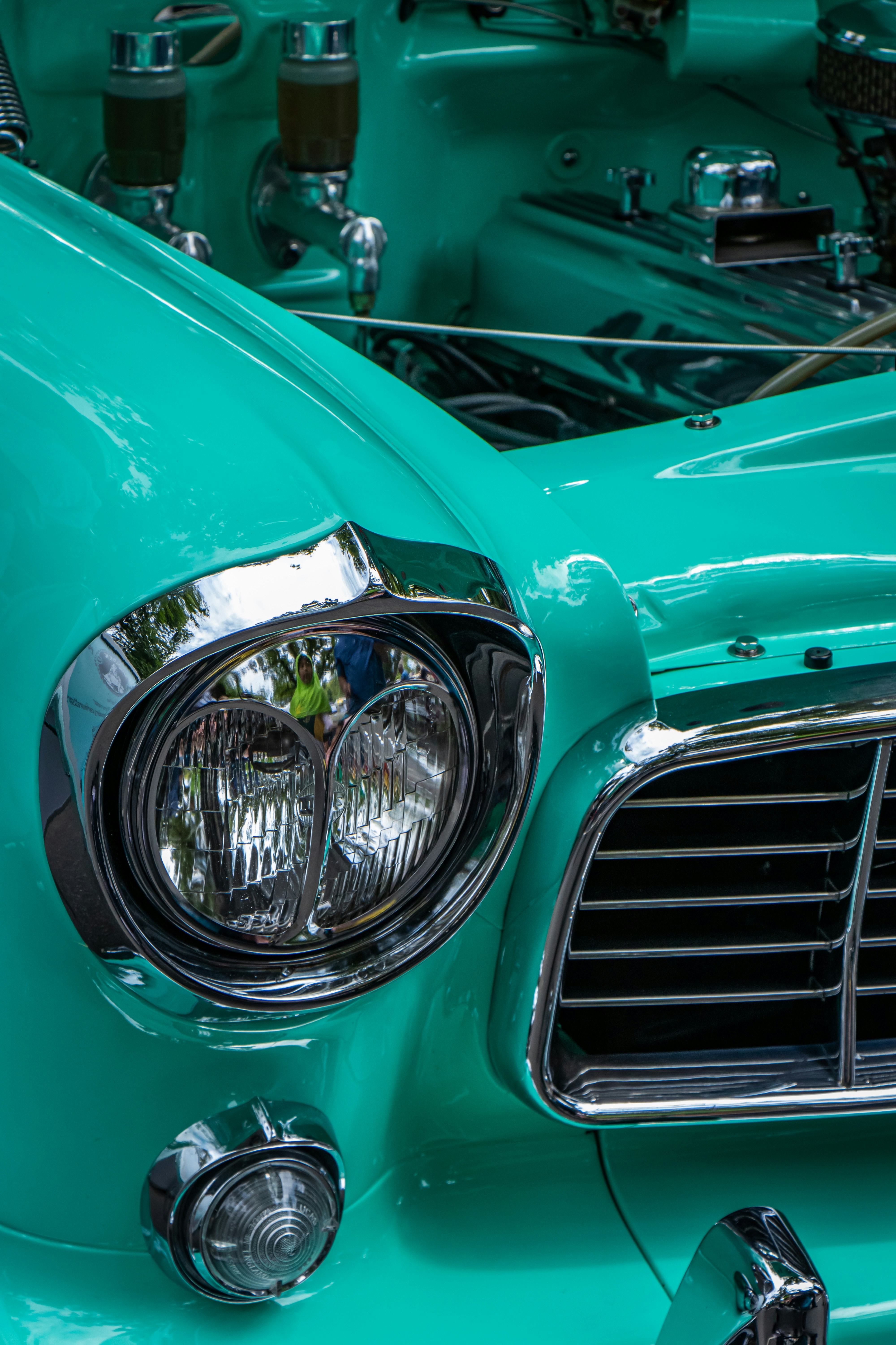Emerald Chrome Face: A Close-Up of a Vintage Turquoise Car Front