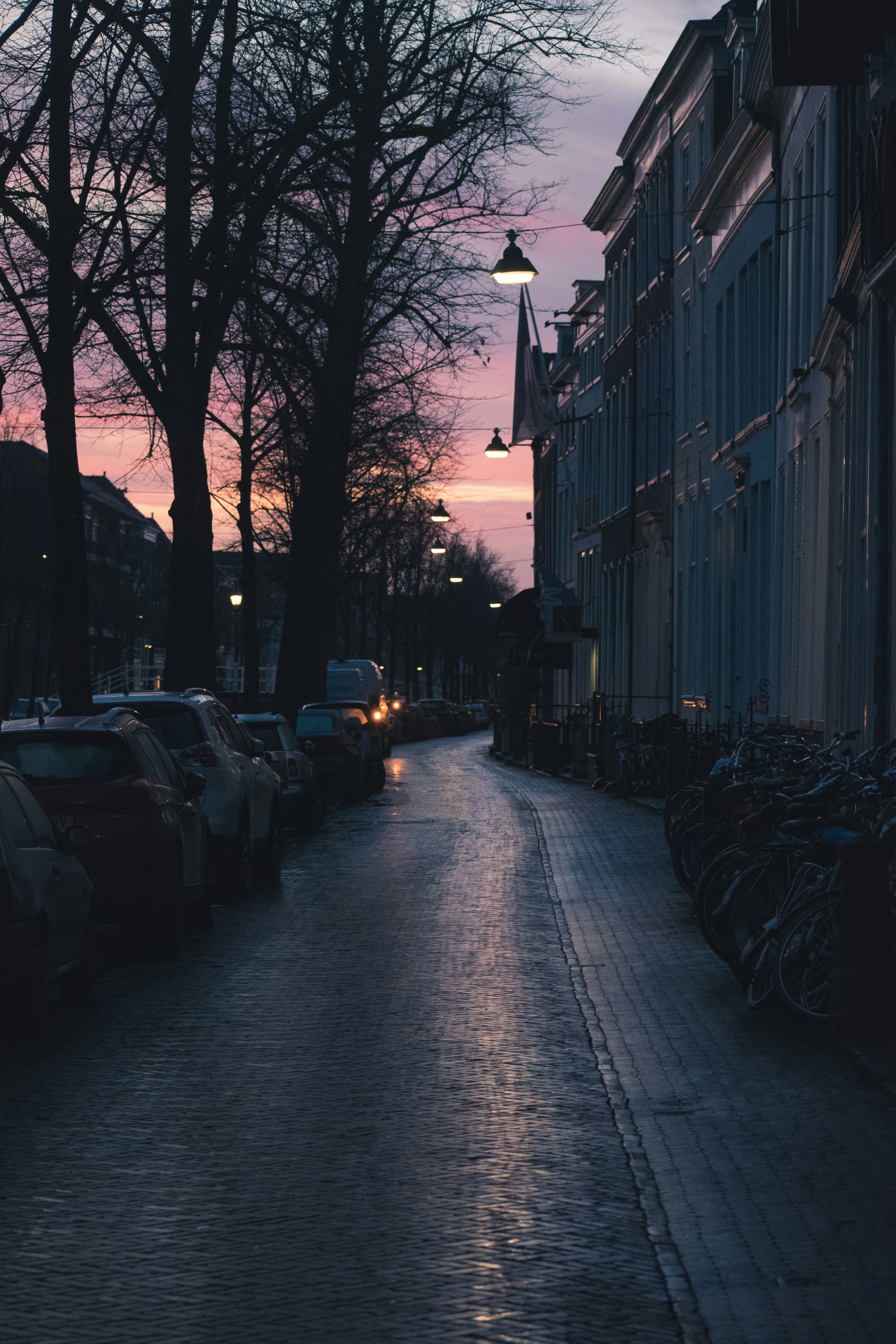 cars parked on side of the road during night time