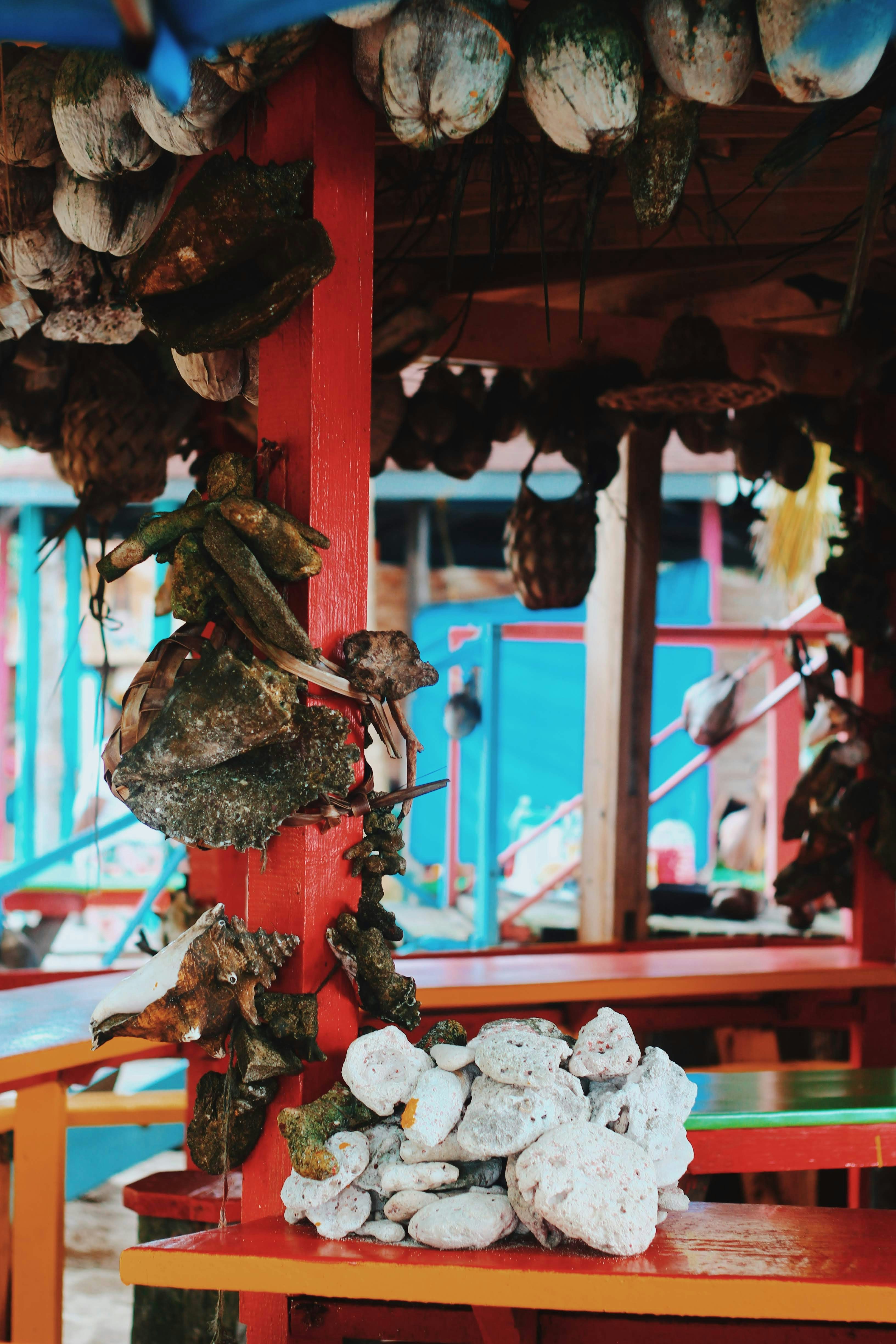 Stone Offerings Beneath a Coral-Red Pavilion