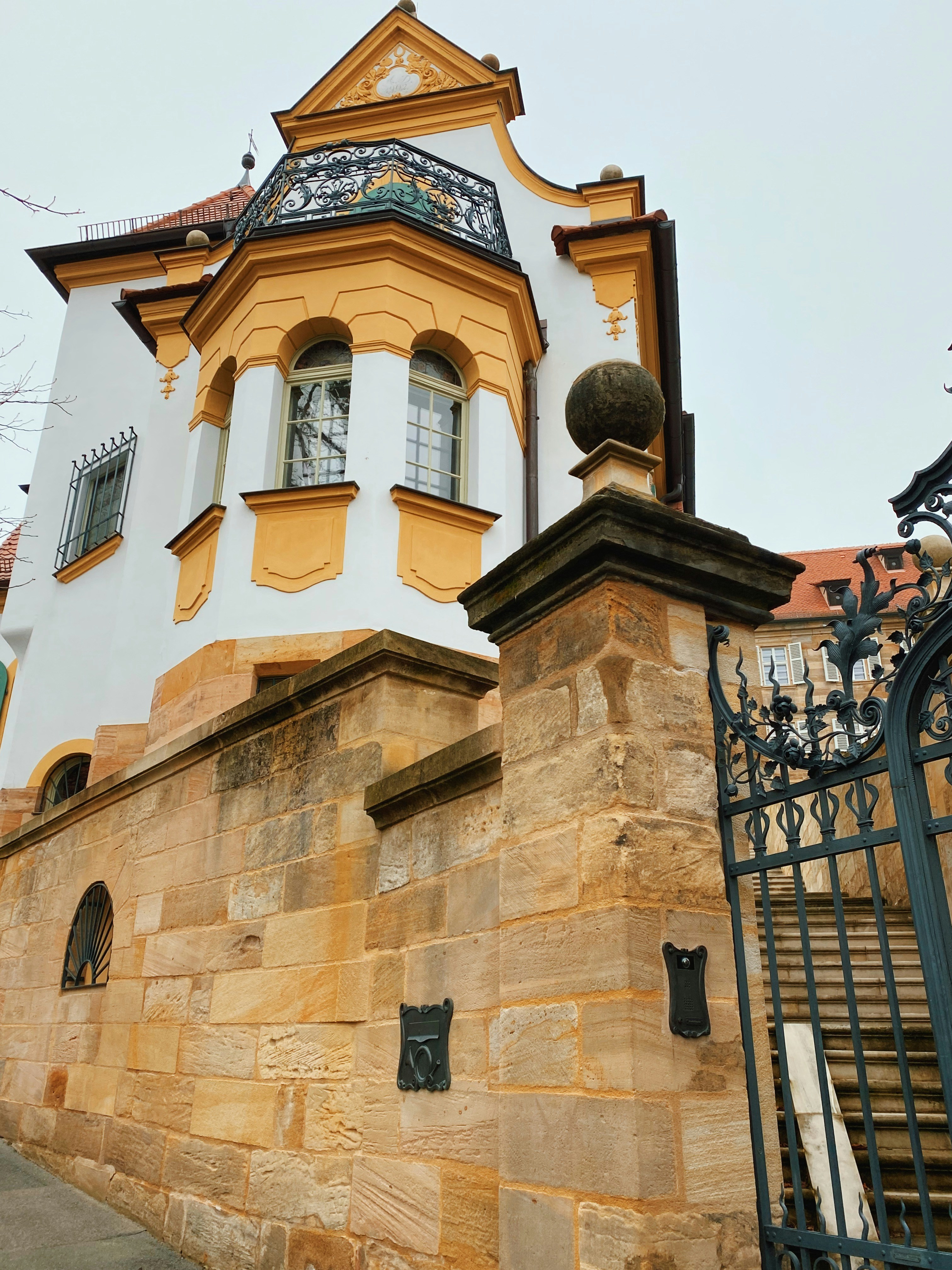 Sunlit Baroque Villa Behind a Weathered Stone Terrace and Iron Gates