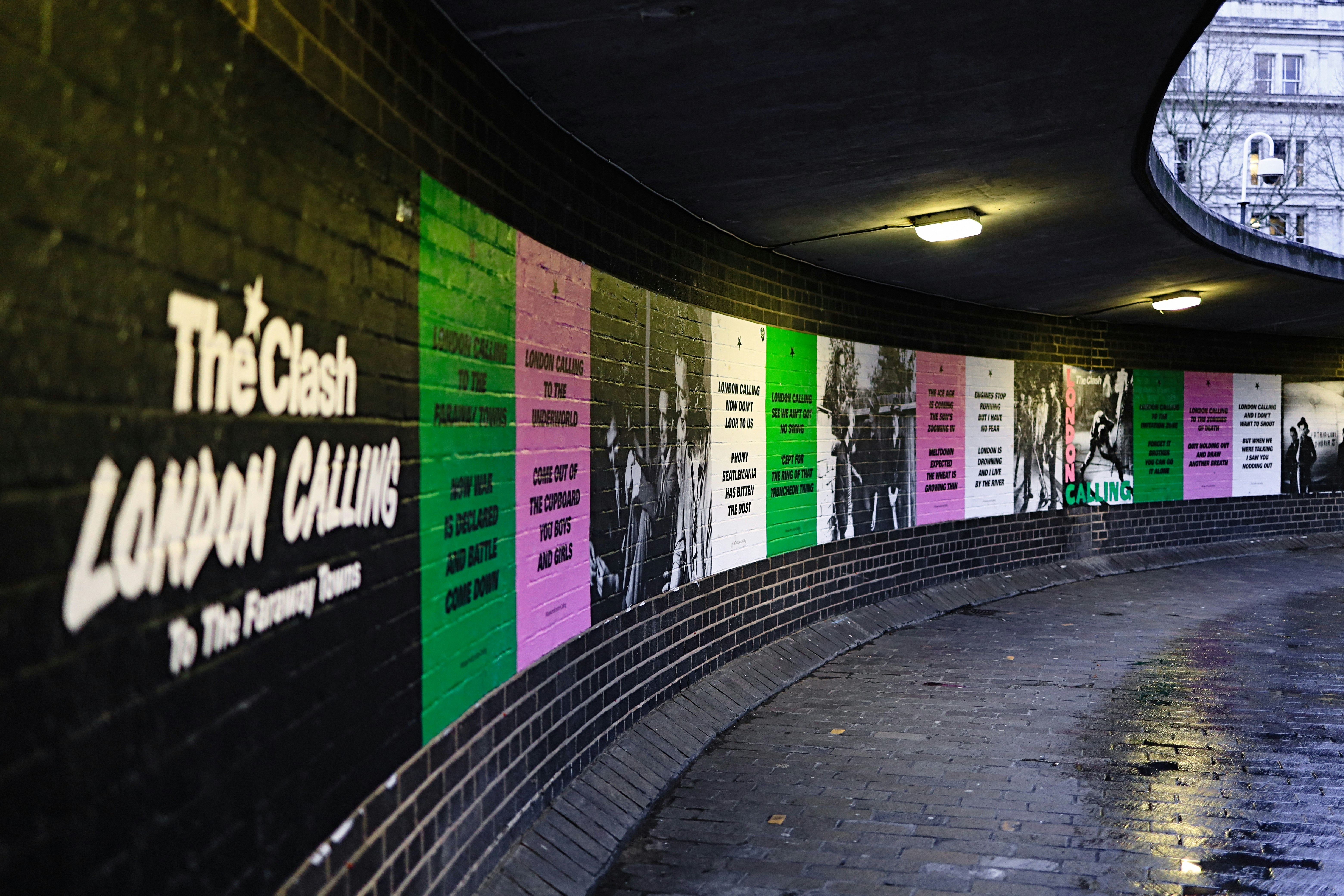 A wall that has a bunch of signs on it photo – Free Path Image on Unsplash