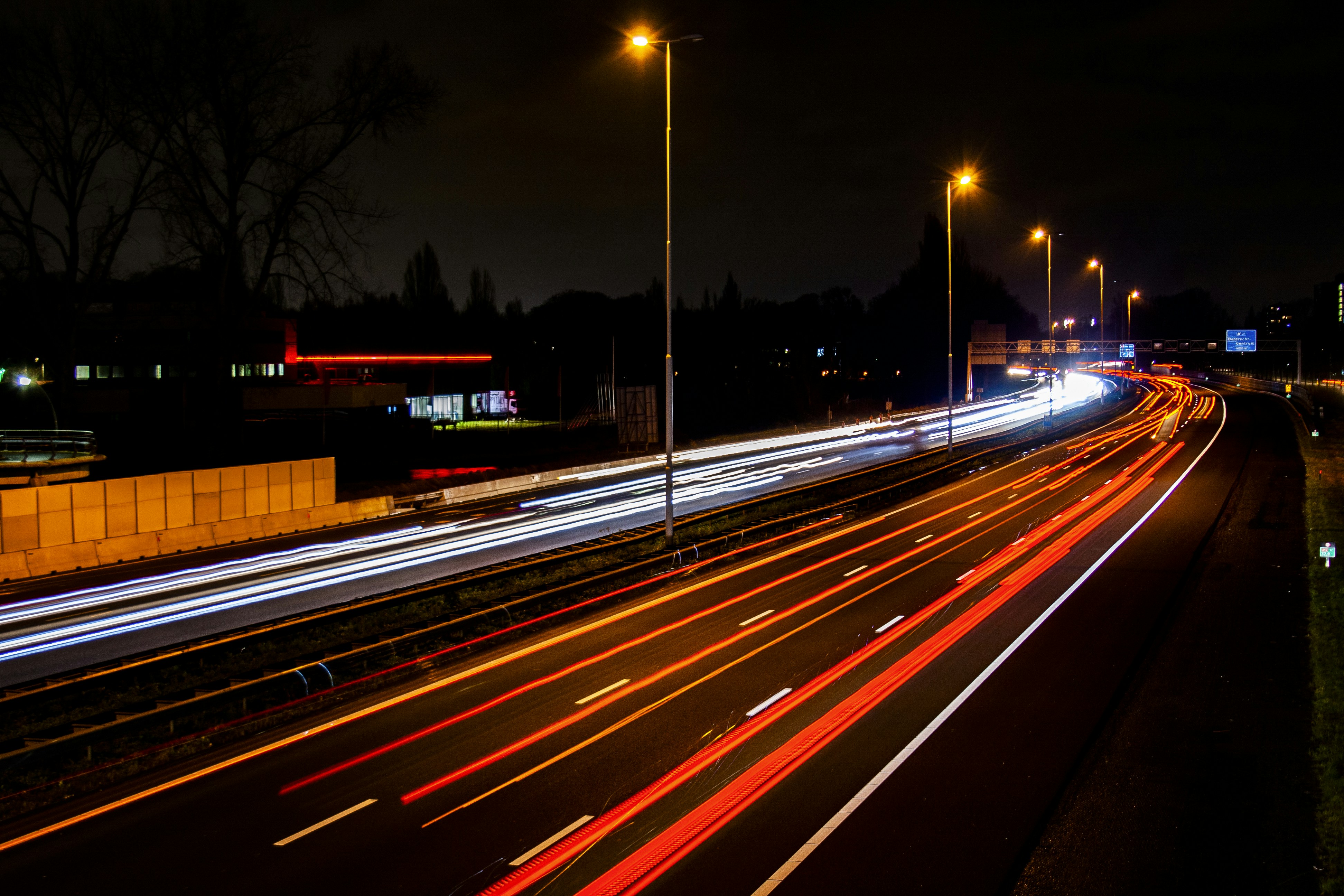 Long exposure of car lights creating vivid streaks on a highway at night.