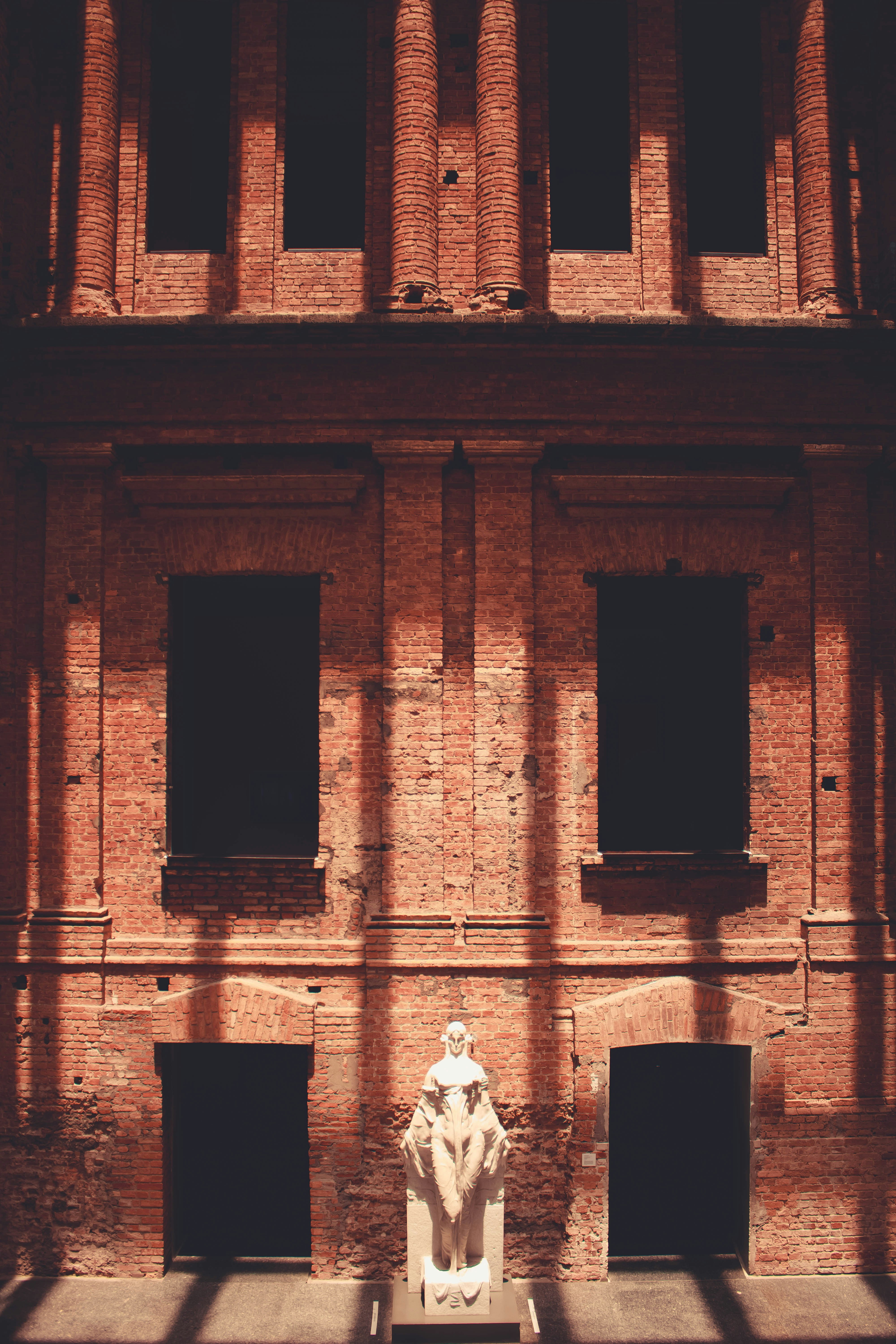 Stone Guardian in a Brick Courtyard at Dusk