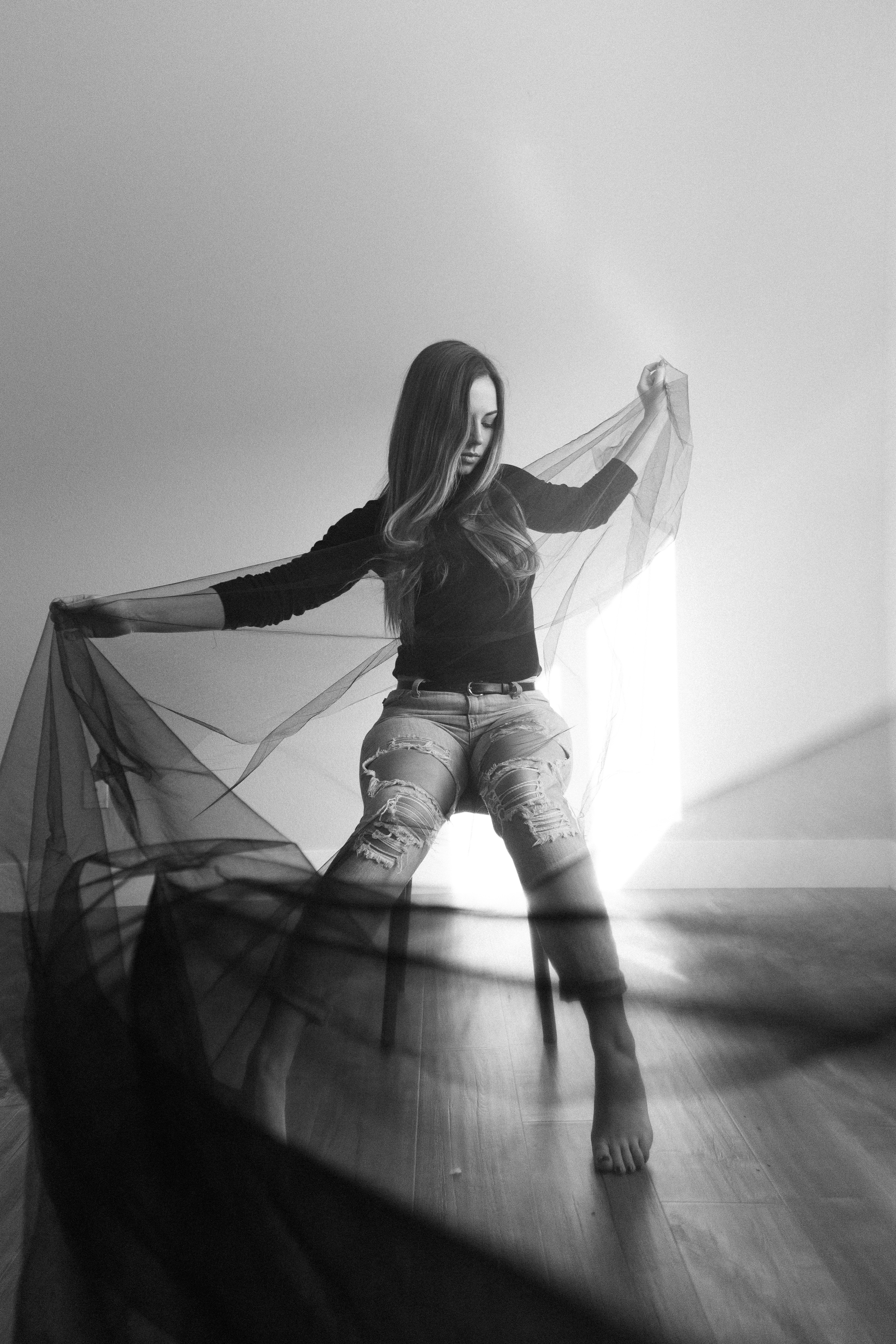 Mid-Tloor Poise: A Veiled Dance with Light and Fabric