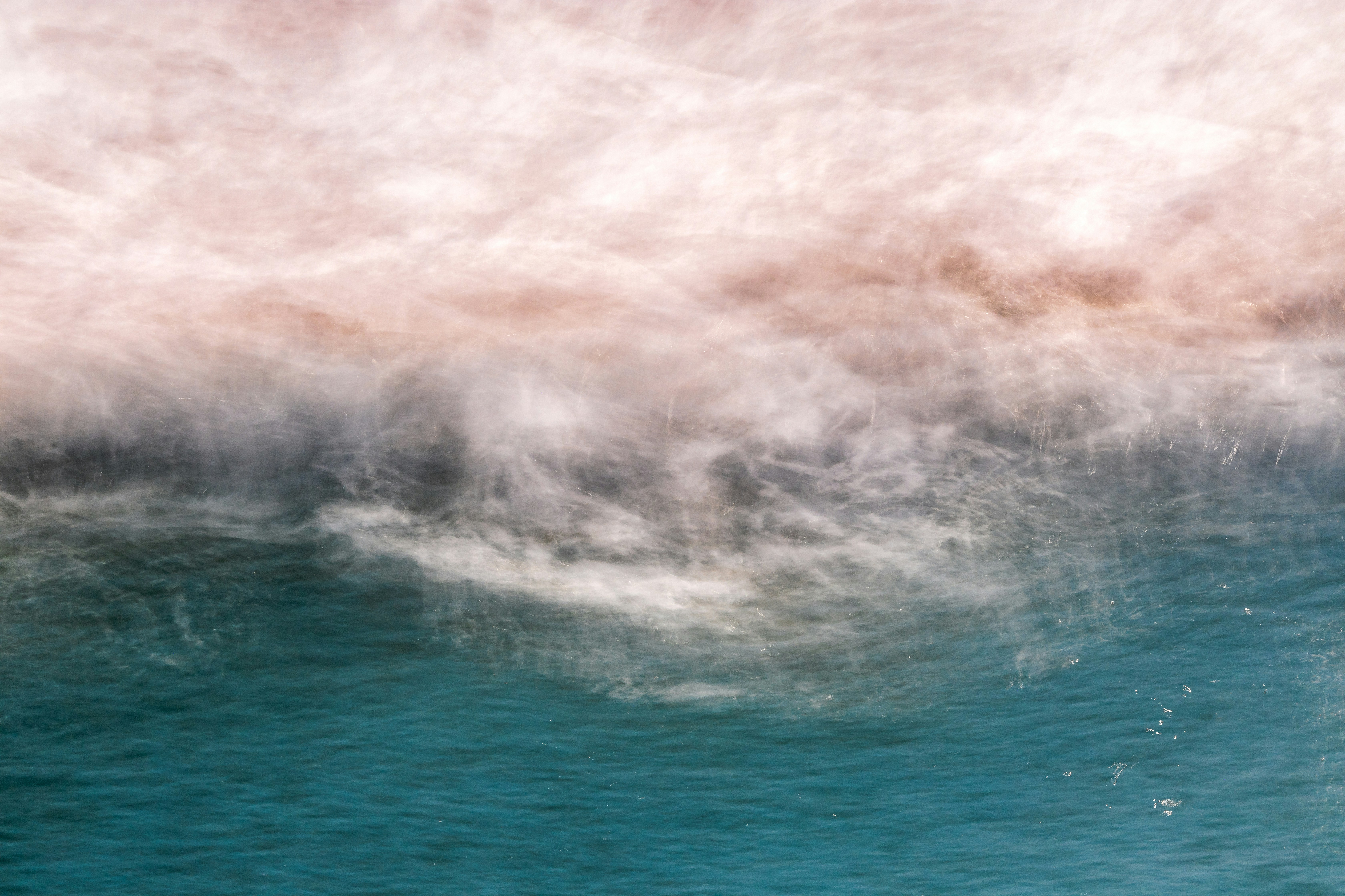 Abstract representation of ocean waves blending with soft clouds, capturing the essence of fluid motion and tranquility.
