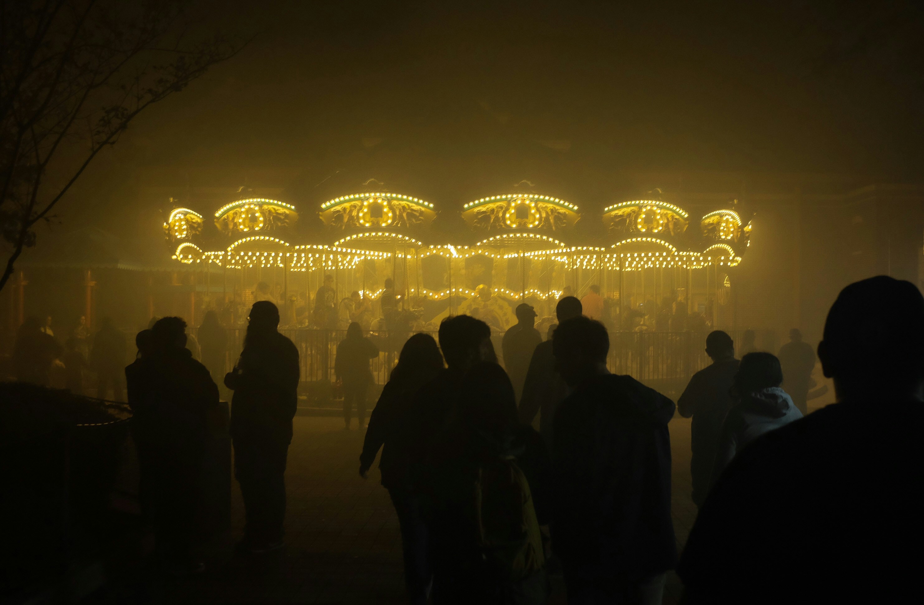 Golden Carousel Glow: Nighttime Crowd Under a Misty Lantern Atmosphere