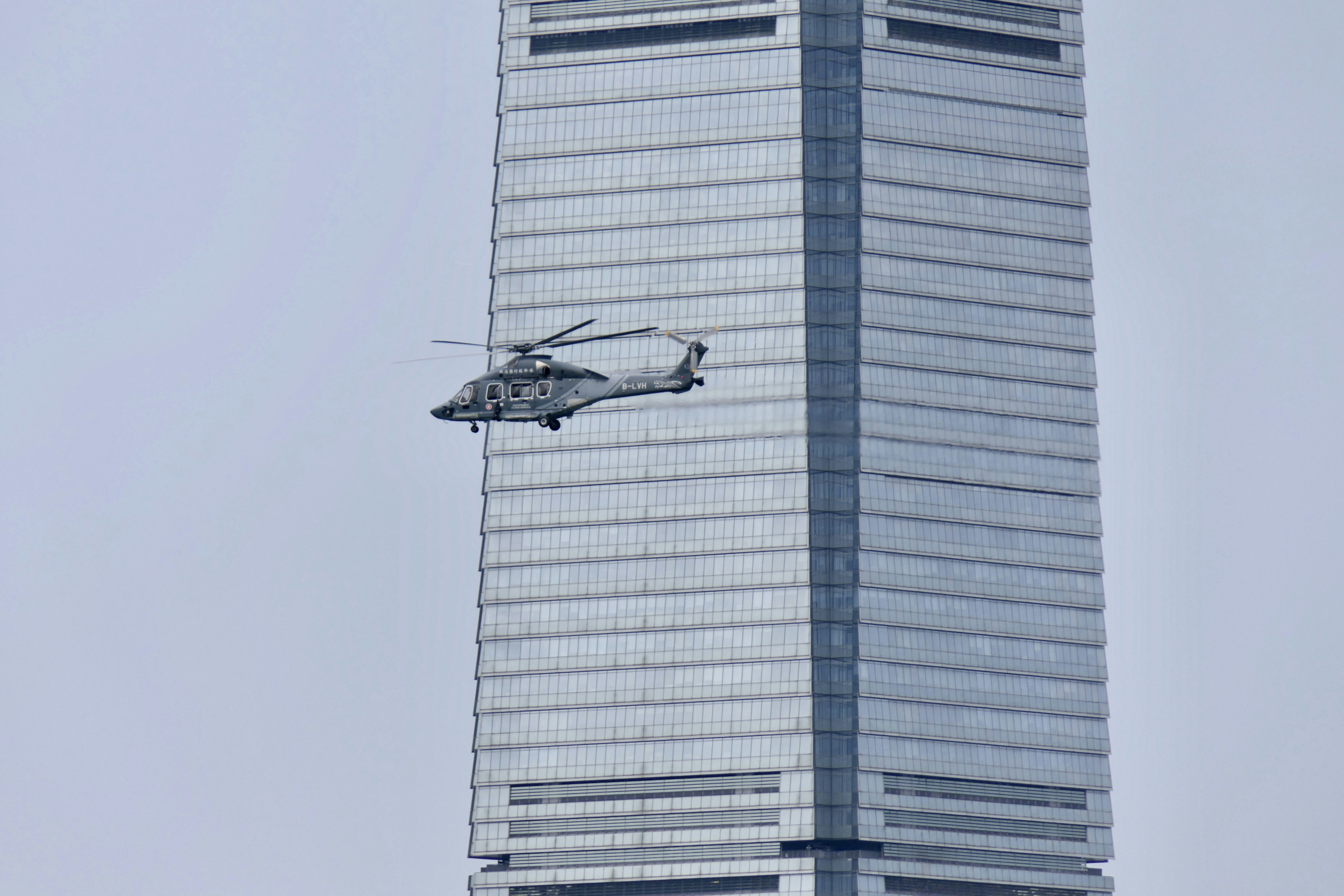 white helicopter flying over the high rise building photo – Free Grey ...