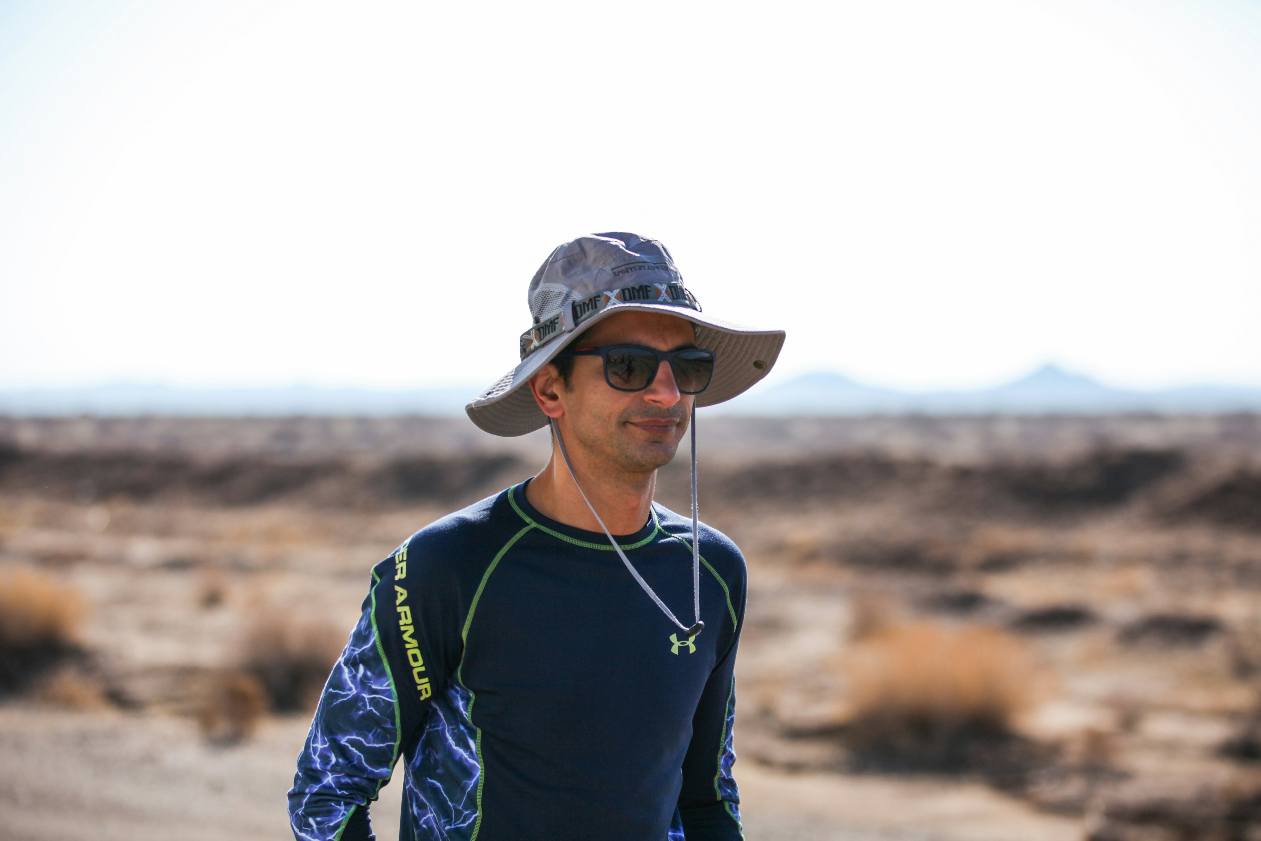 Desert Light: Portrait of a Hat-Wearing Wanderer in a Quiet Horizon
