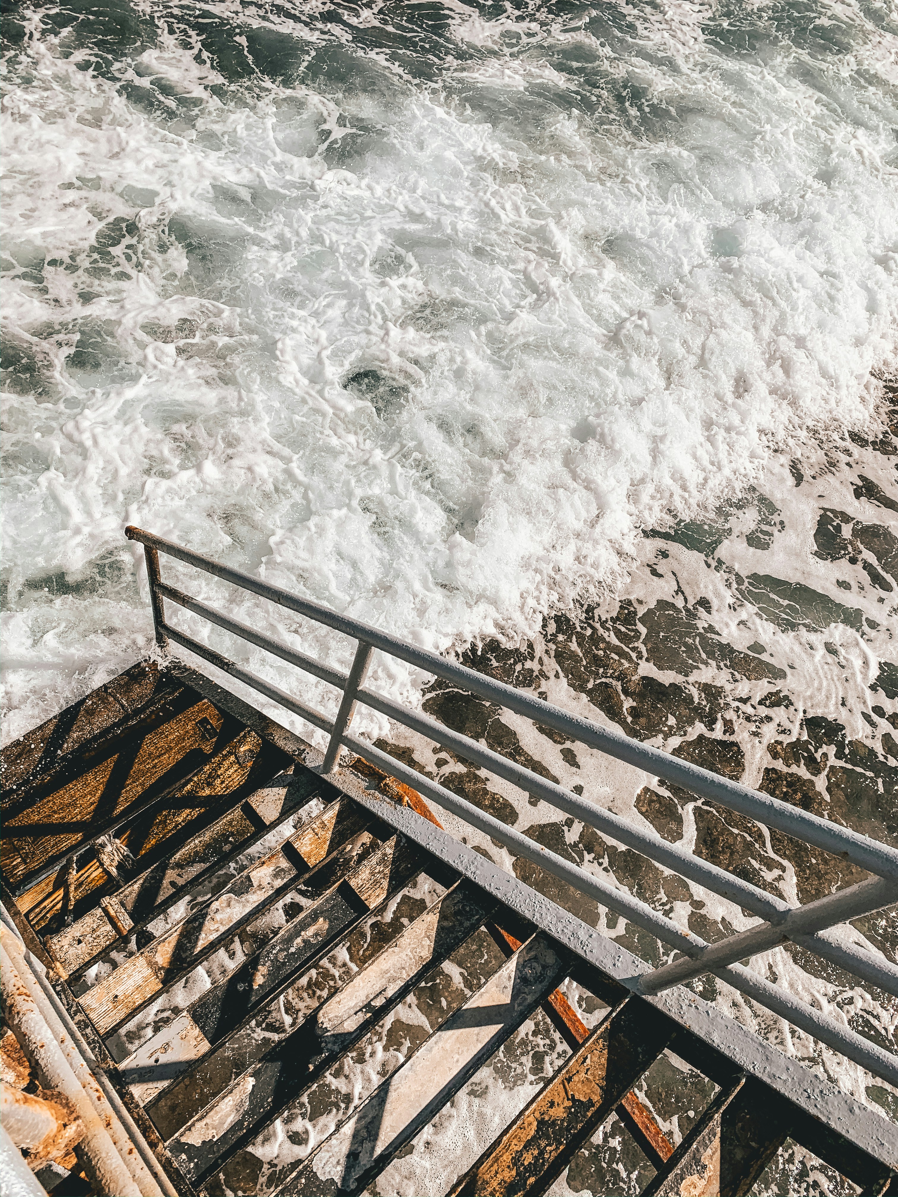 Railing Over the Surf: A Staircase to the Foam