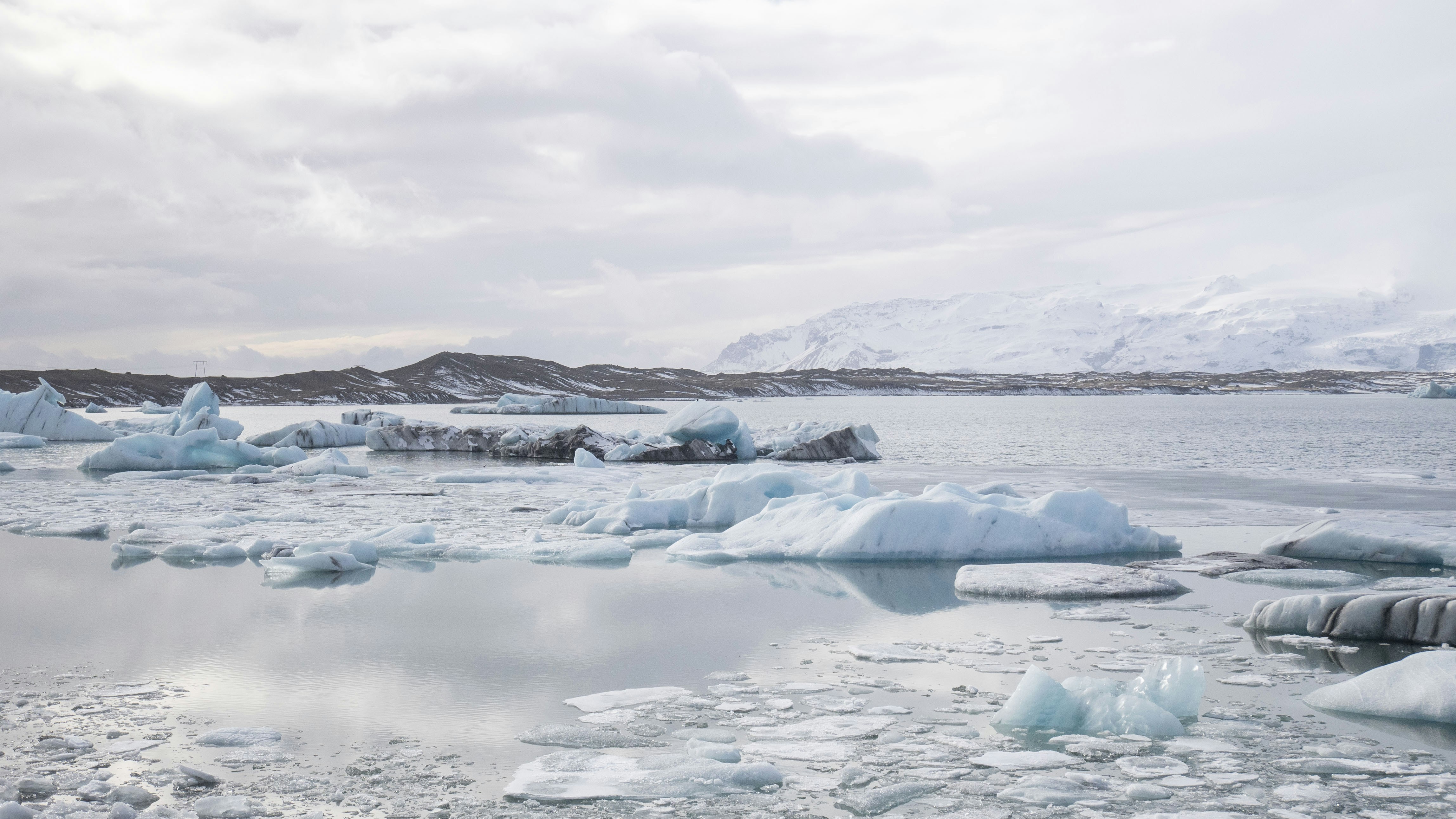 Snow covered field under cloudy sky during daytime photo – Free Iceland ...