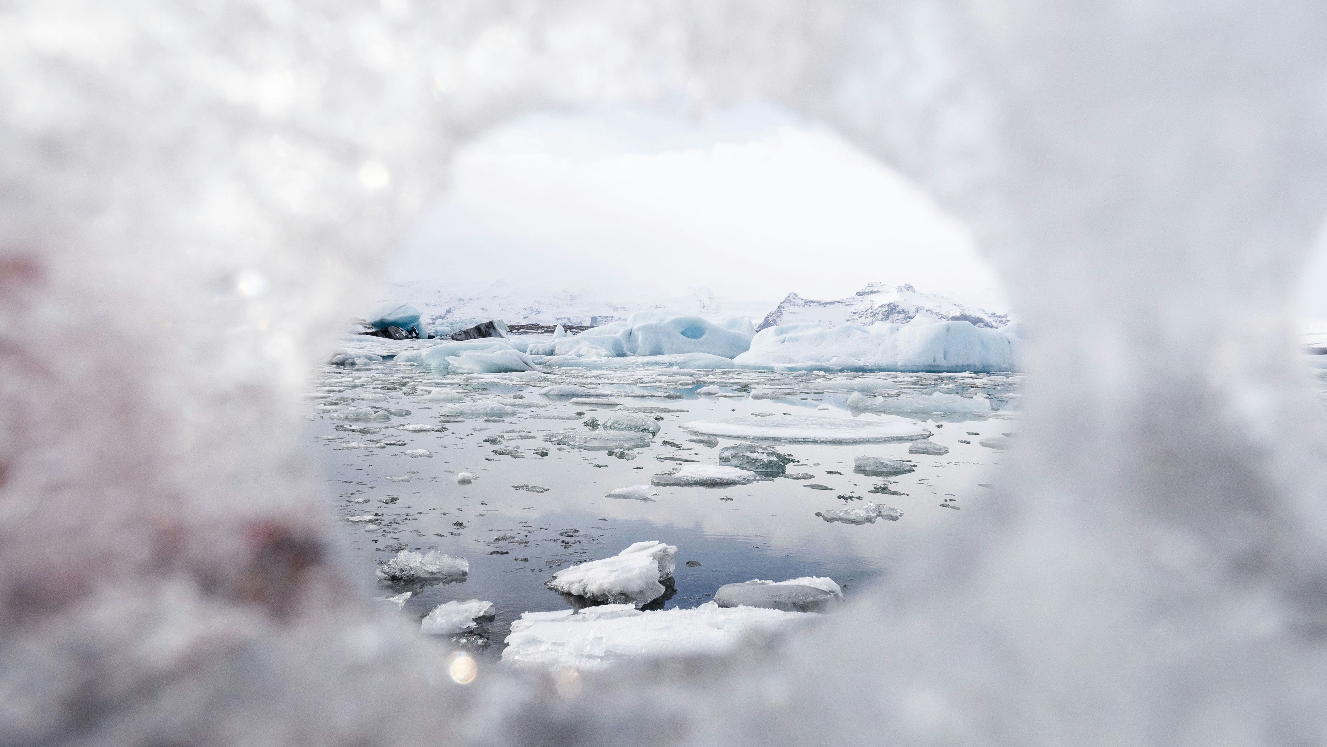 Icebound Window: Fractured Glaciers Framed by Snowy Ridge