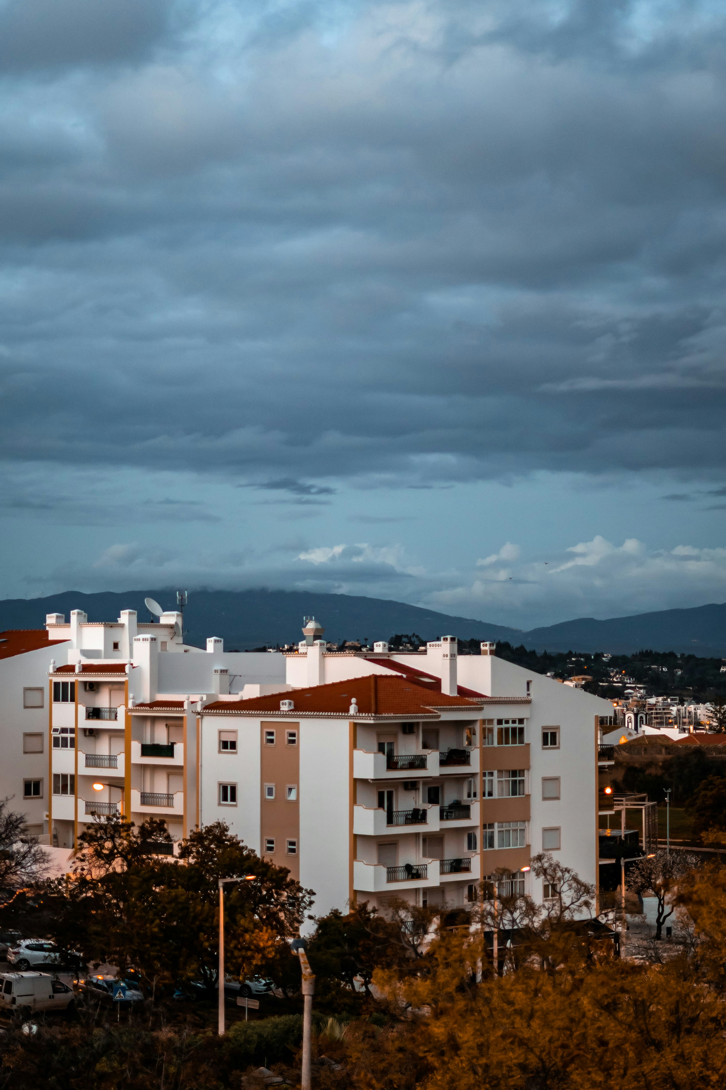 Cobalt Sky Over White-Walled Flats: Hilltop Calm