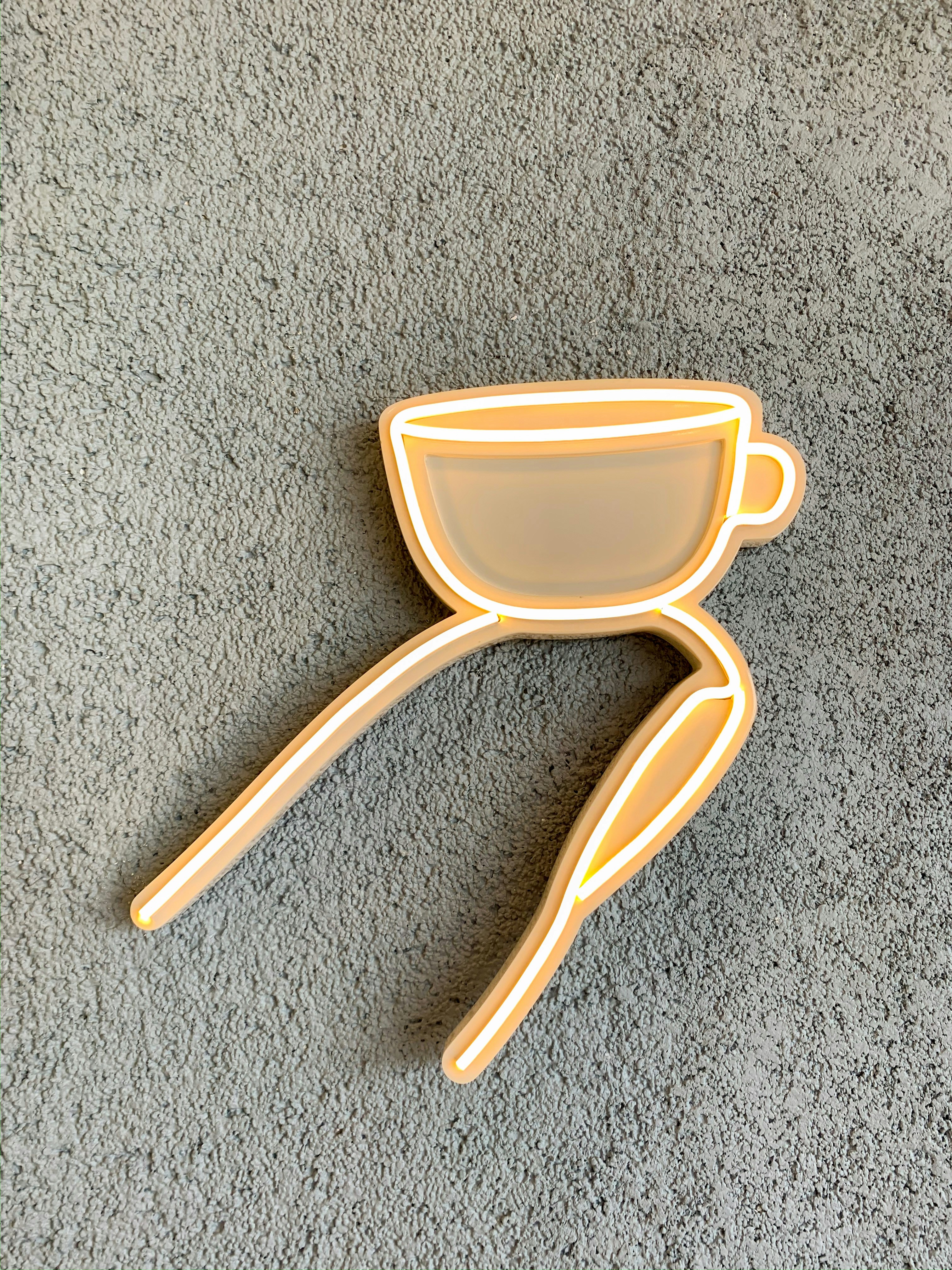 orange plastic hair clip on gray textile