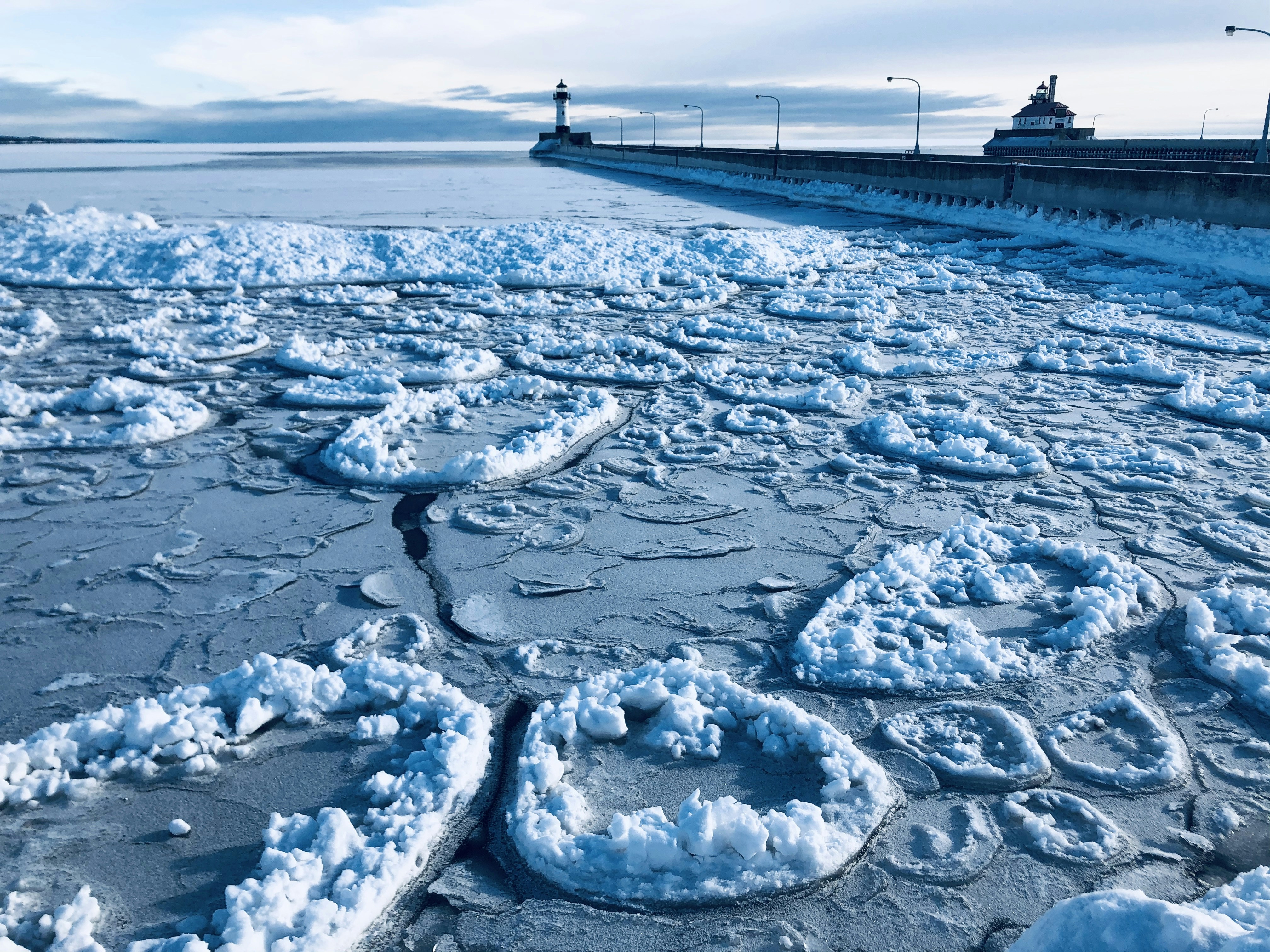 Frozen Pier Confluence: Ice Crystals Meet a Distant Breakwater