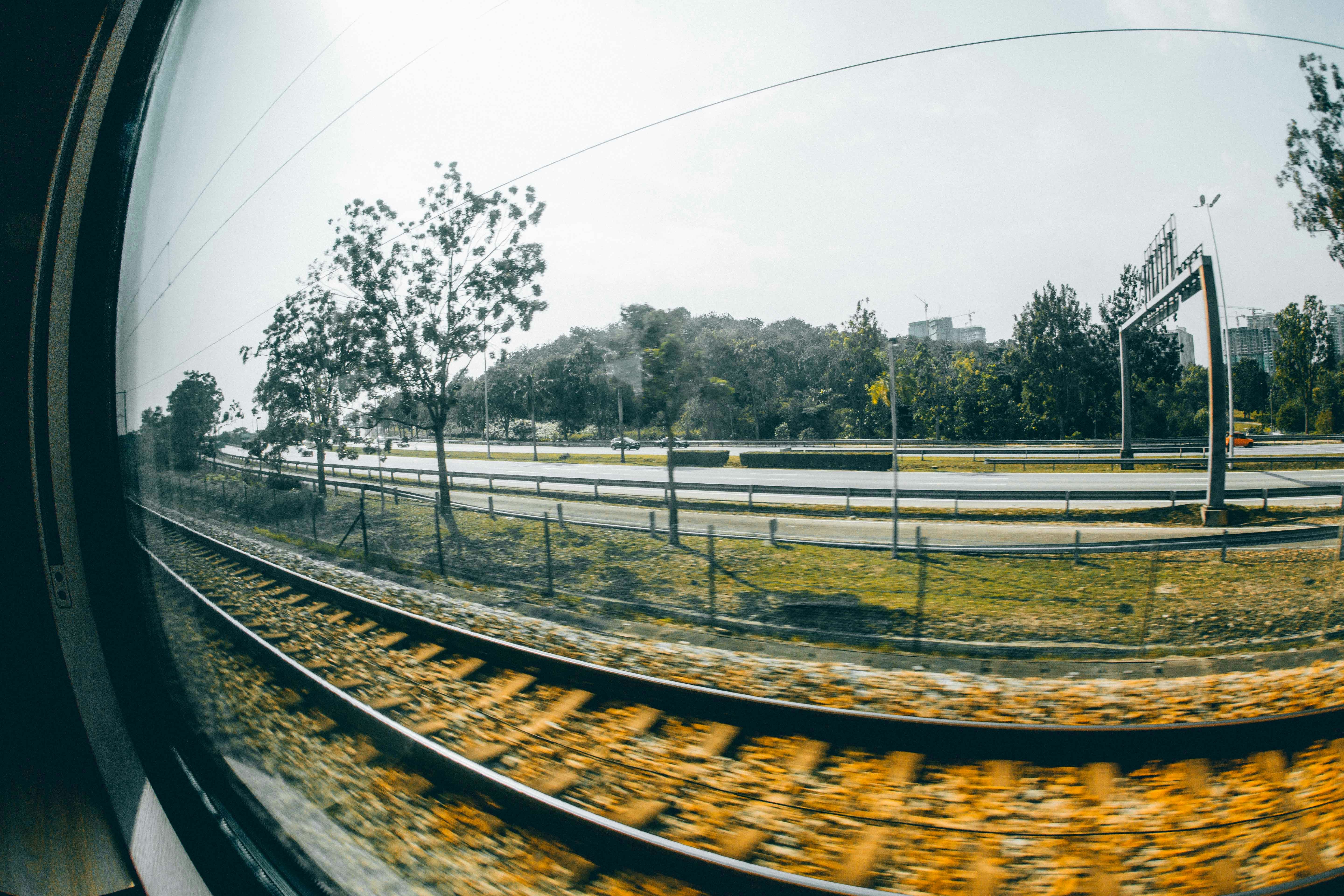 train rail near trees during daytime