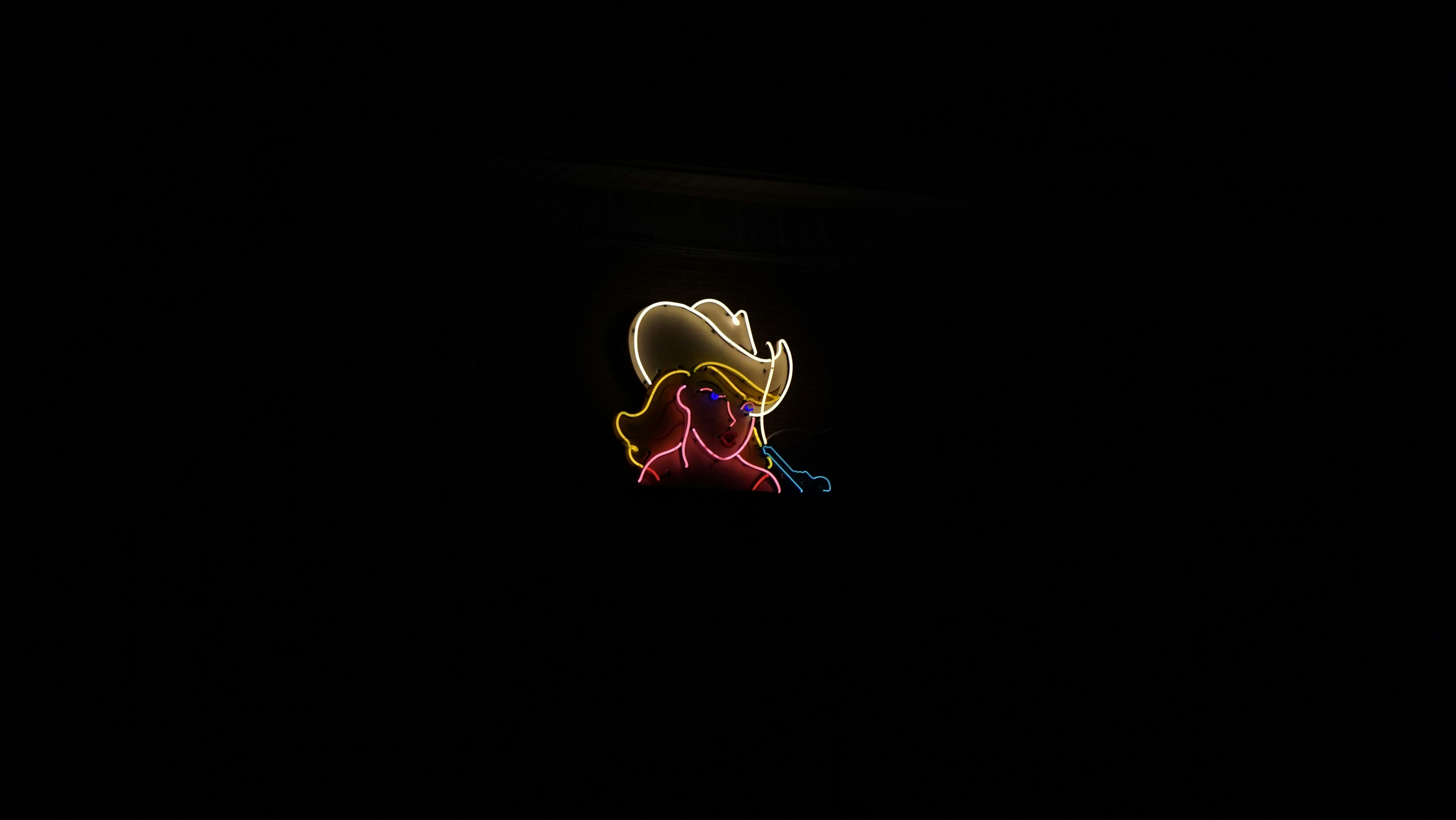 Neon Cowboy silhouette in the dark