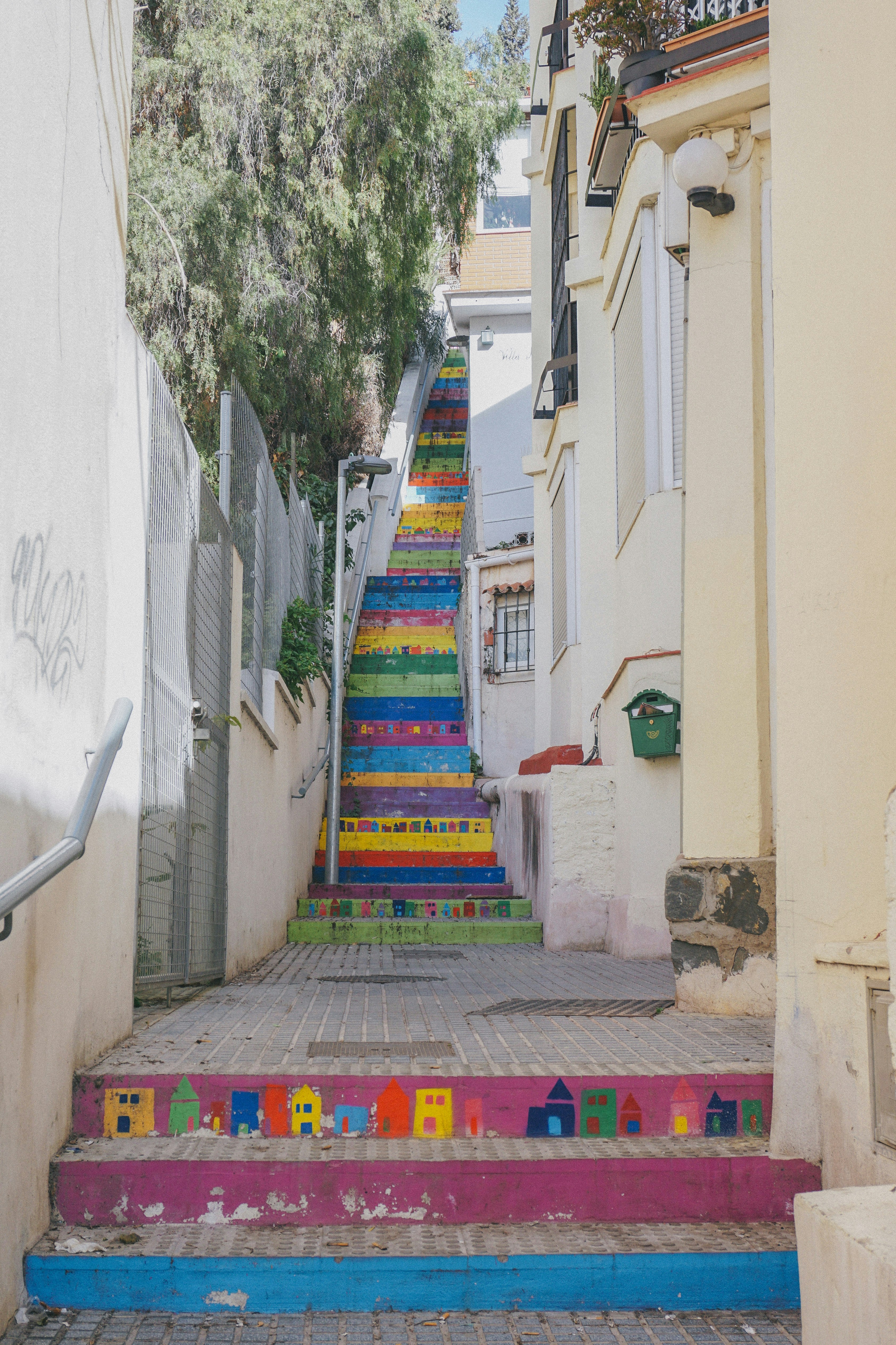 Chromatic Staircase: A Rainbow Ascent Through a Sunlit Alley
