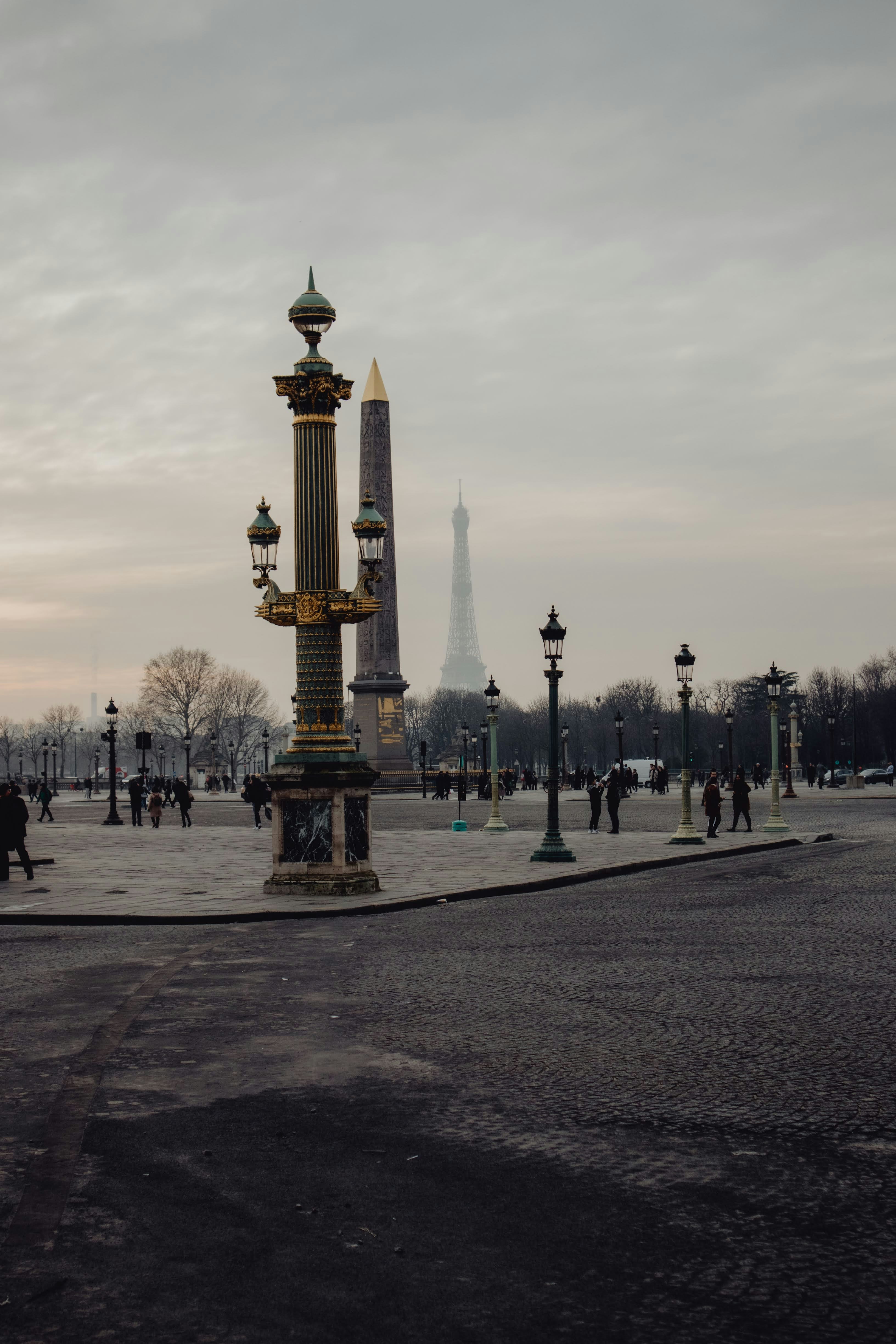 Luxor Obelisk at Dusk: Lanterns, Fog, and a Distant Eiffel