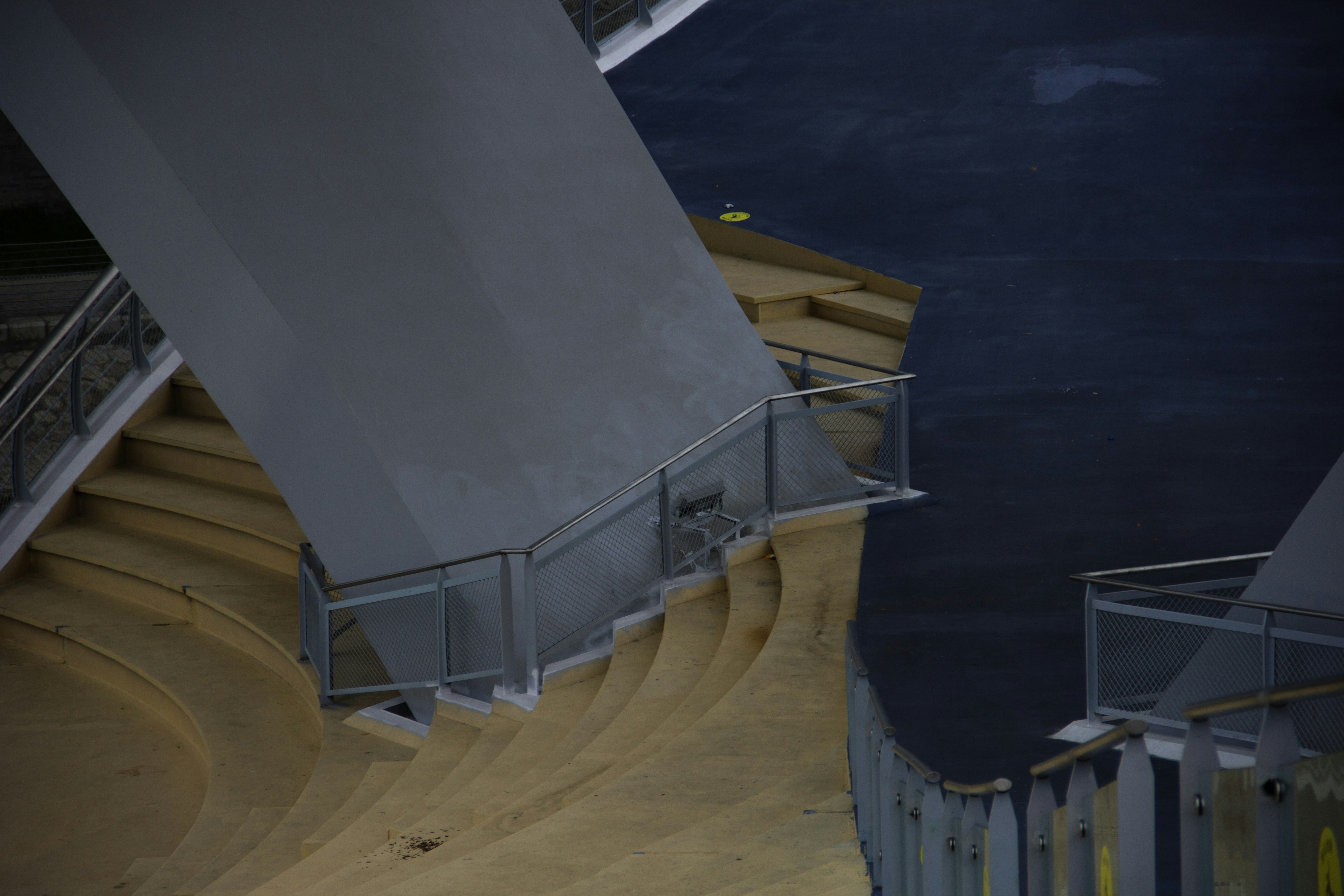 Steel Diagonal Across Sandstone Curves: Geometry in an Industrial Amphitheater