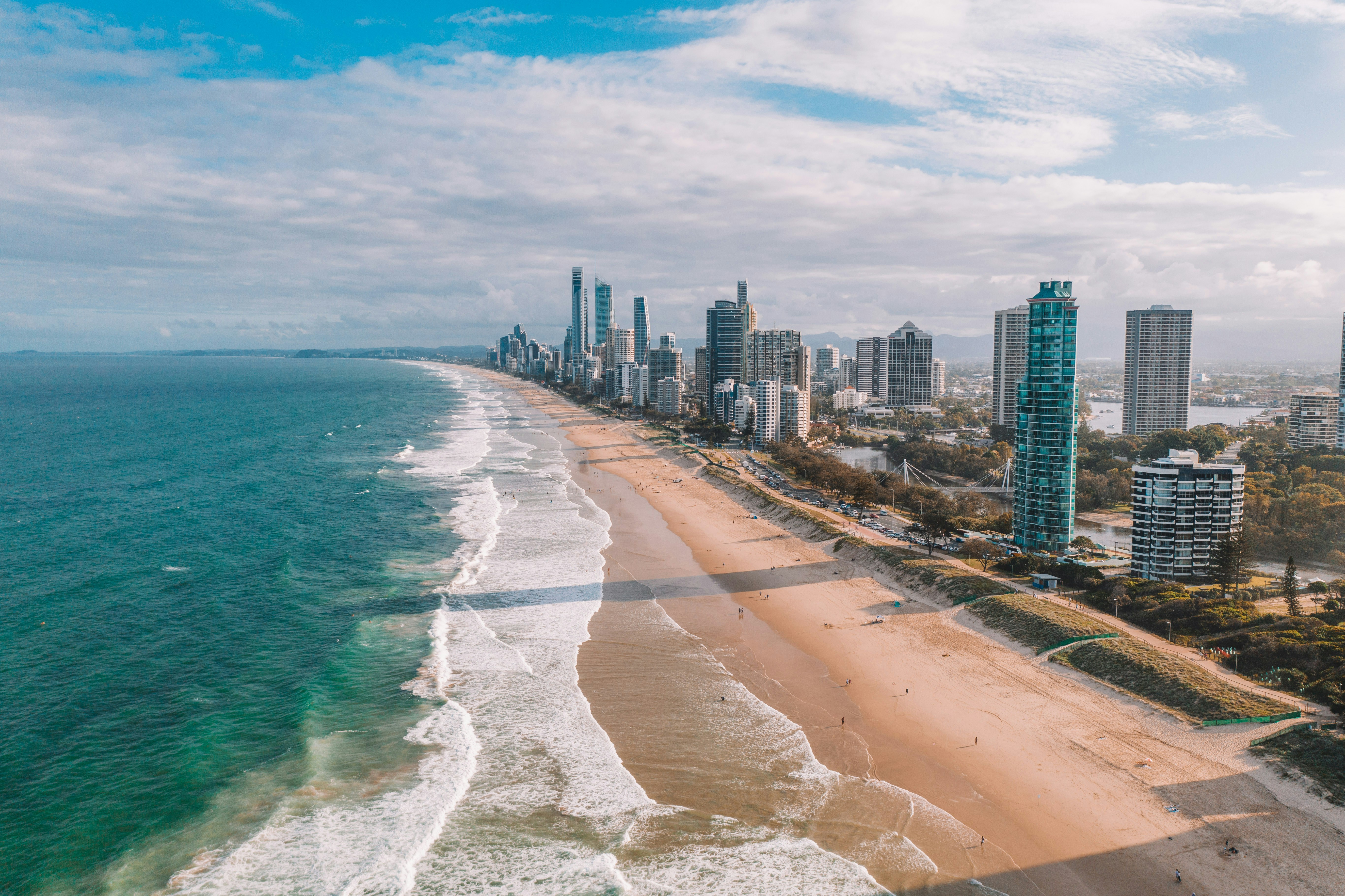 High rise buildings near sea under blue sky during daytime photo – Free ...