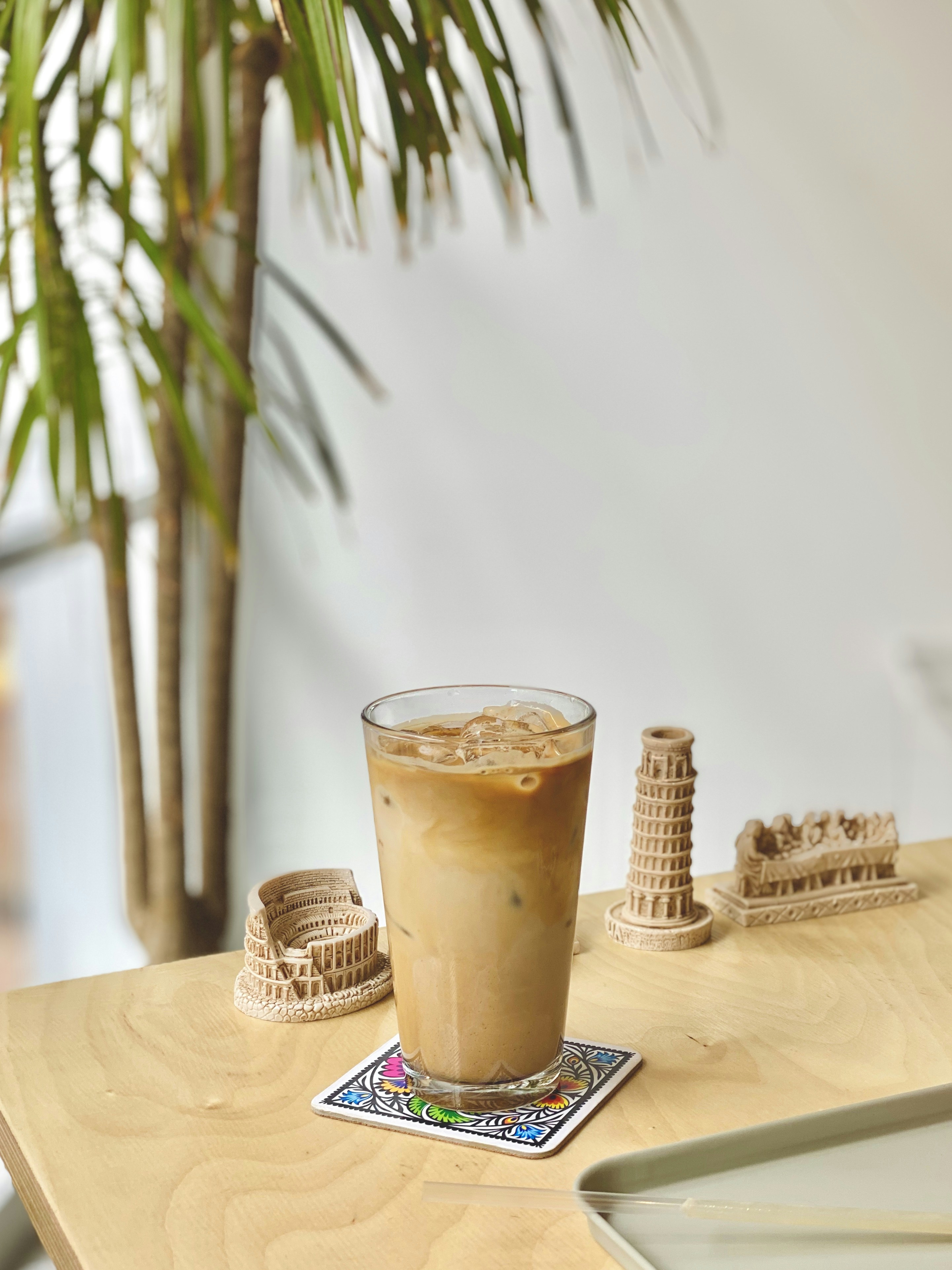 Iced Coffee Still Life: Warm Countertop and Miniature Landmarks