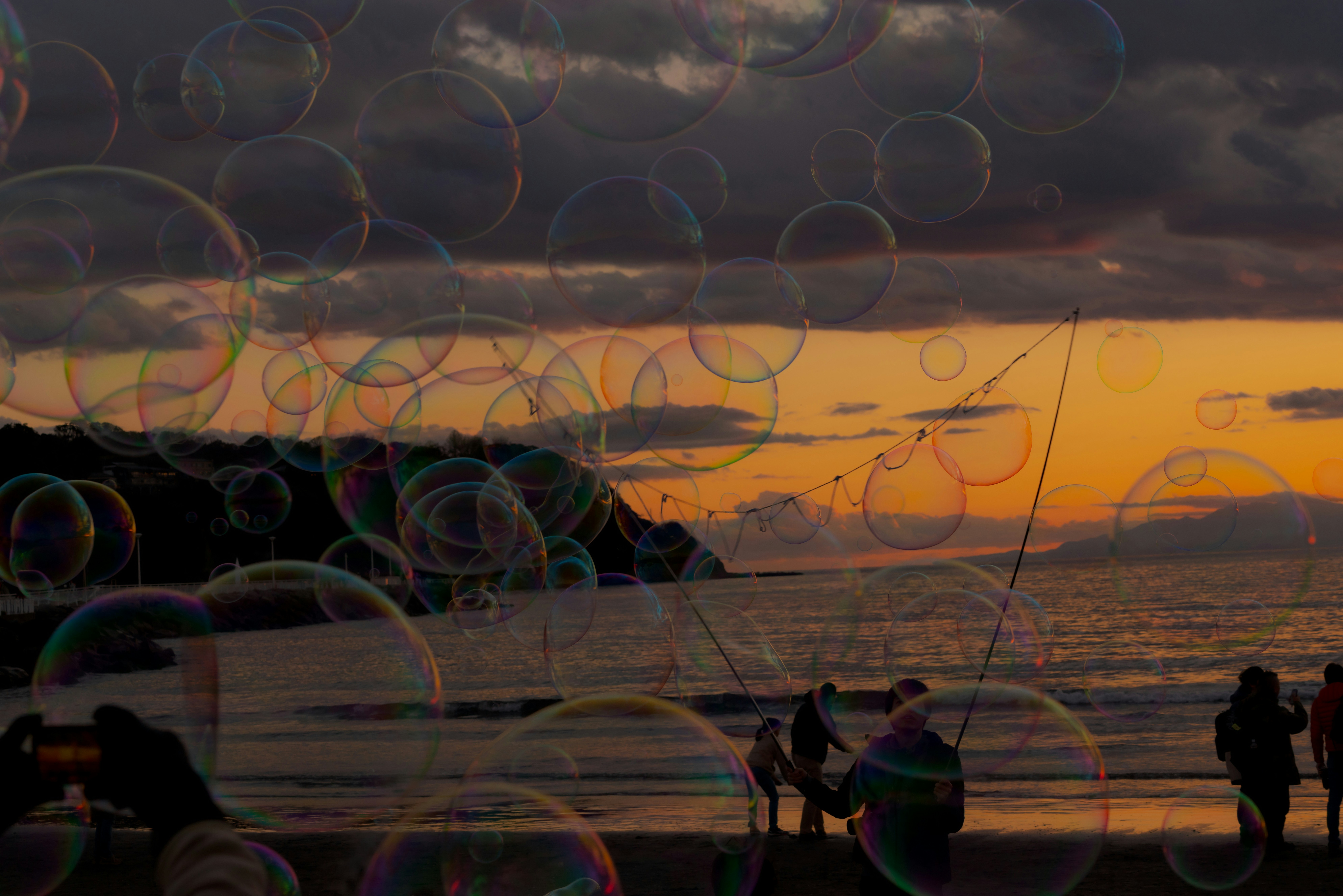 silhouette of people on beach during sunset