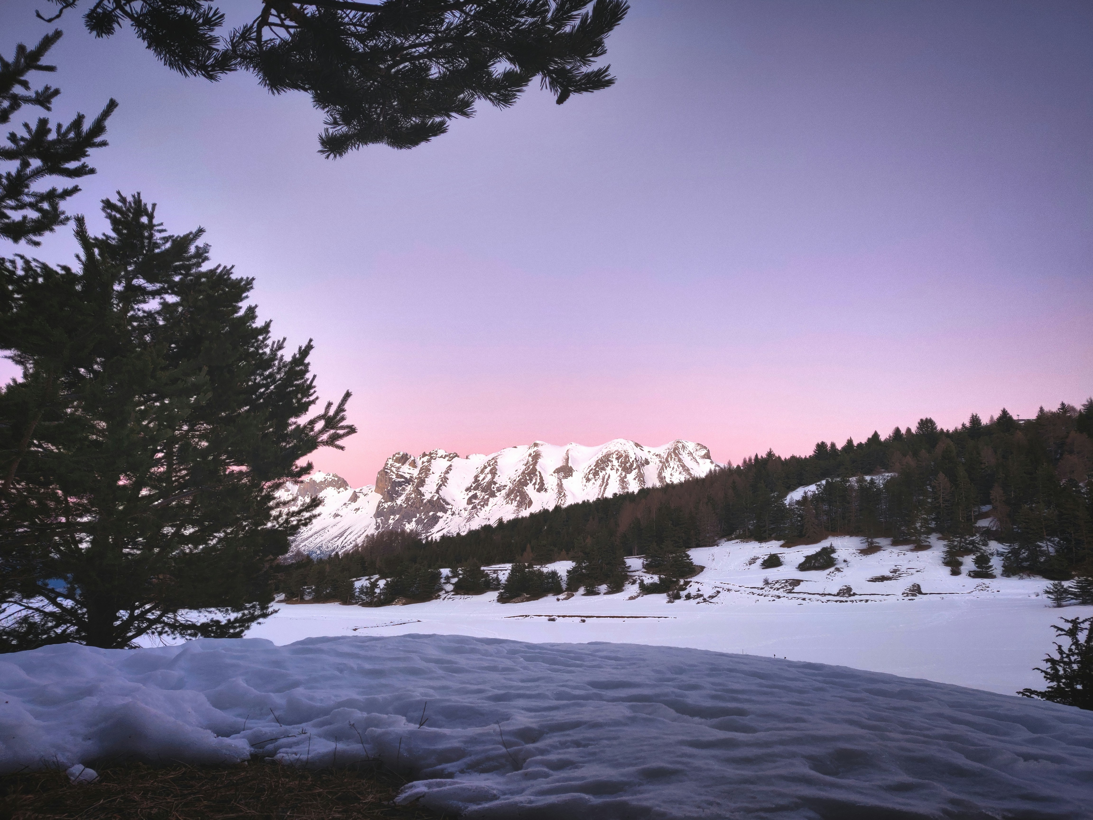 Twilight Ridge: Snow-Capped Peaks under a Pinkened Sky
