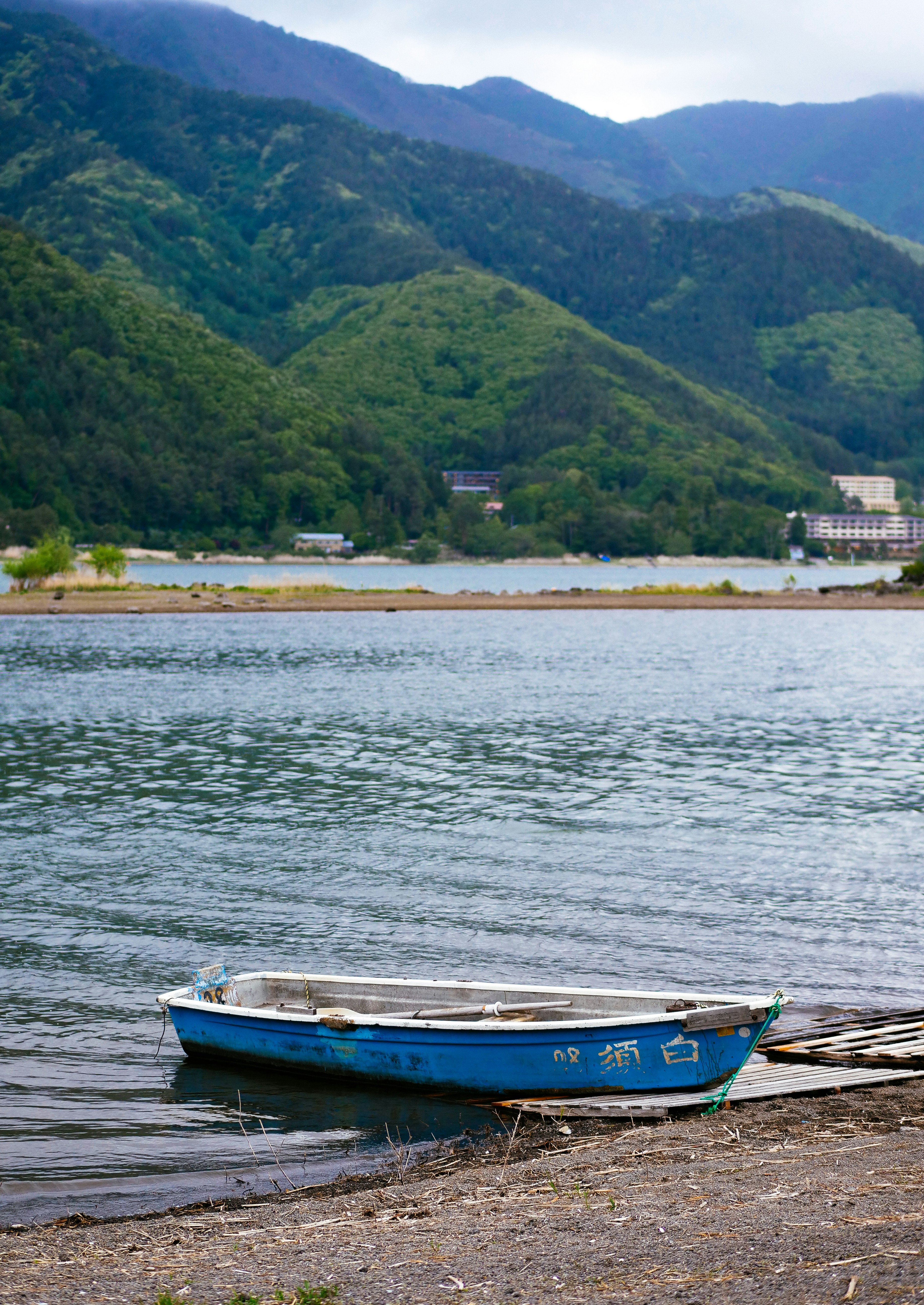 An old rusted boat on the shore of a lake near Mt. Fuji in Japan.